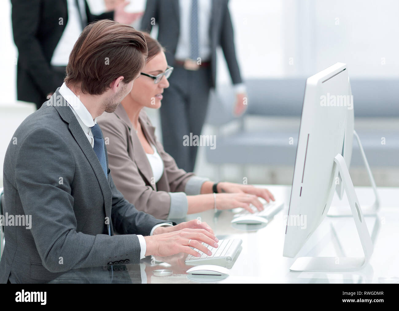 employees sitting at a Desk in the Bank office Stock Photo - Alamy