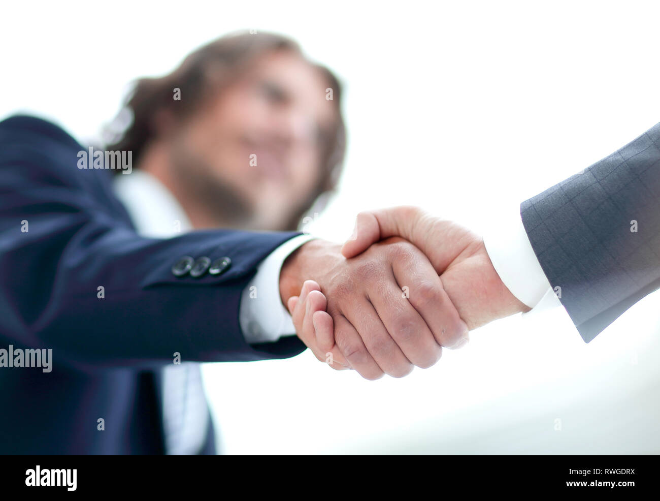 Two businessman shaking hands greeting each other Stock Photo - Alamy