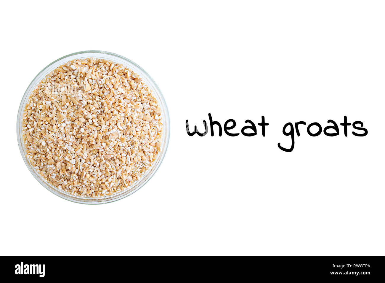 Wheat groats in a glass bowl. View from above. White isolate Stock ...