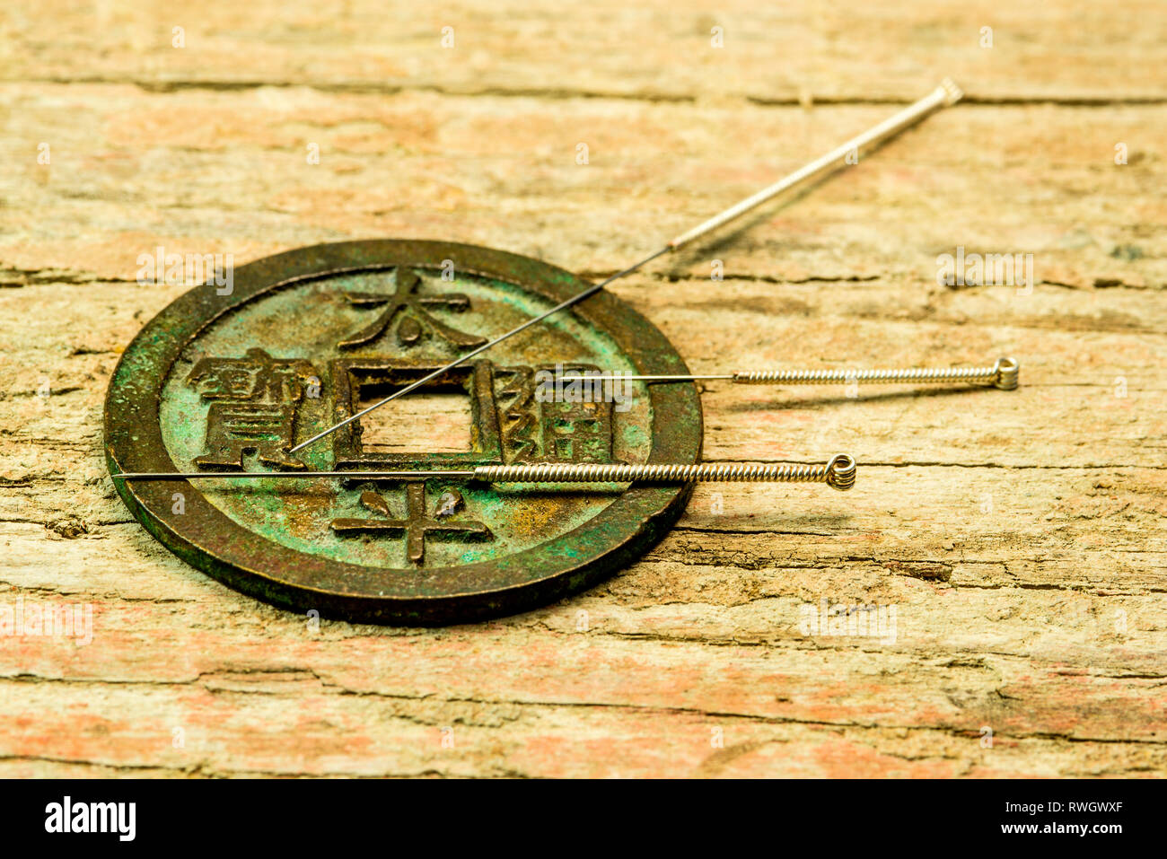 acupuncture needles on antique Chinese coin Stock Photo - Alamy
