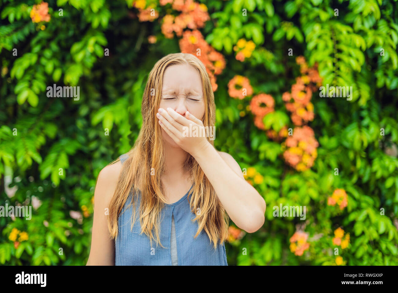 Young pretty woman blowing nose in front of blooming tree. Spring allergy concept Stock Photo ...