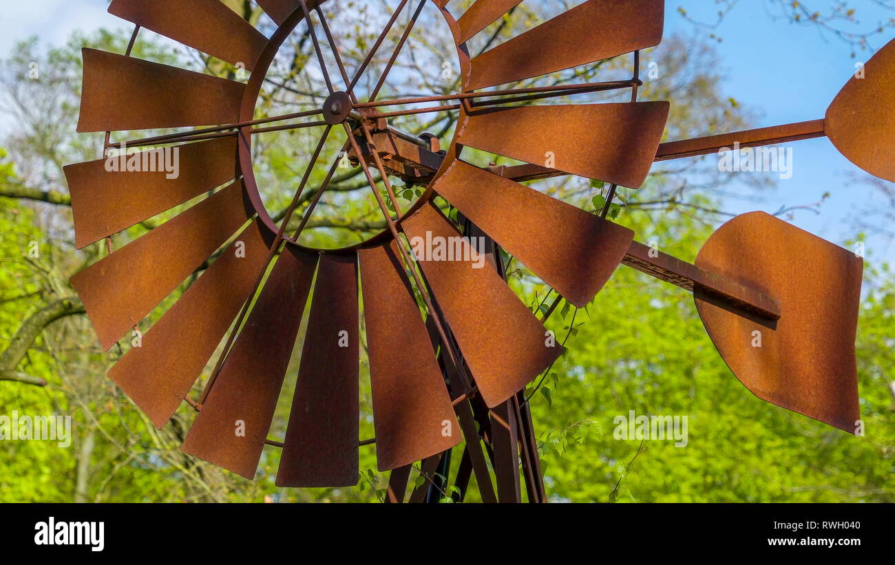 The closer look of the rusty propeller of the windmill slowly turning ...
