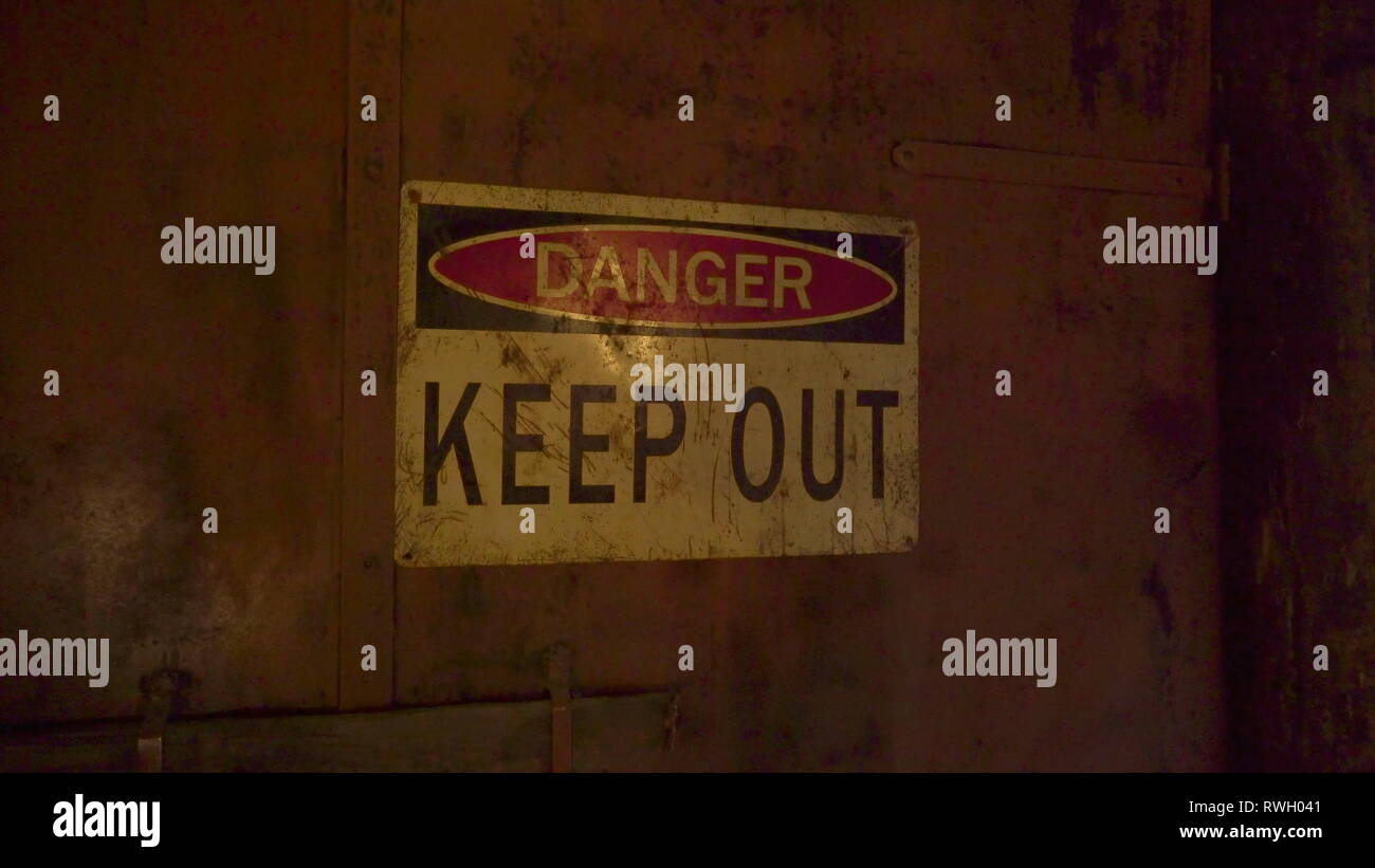 A danger sign on the gate of the mining area where it means it is a ...
