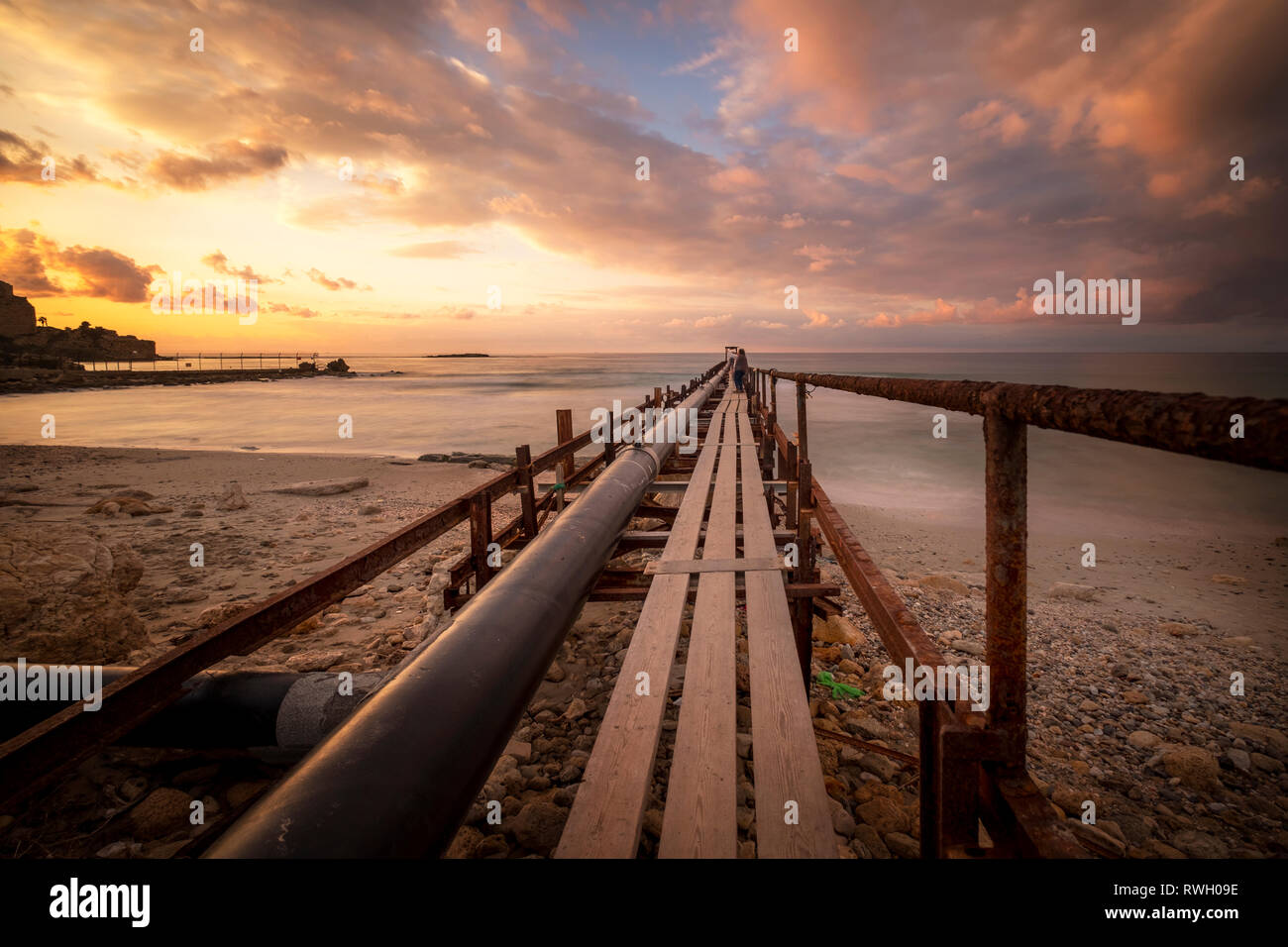 sunset at Atlit beach with a old woden pier, Israel Stock Photo - Alamy