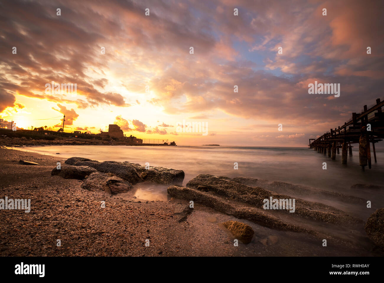 sunset at Atlit beach with a old woden pier, Israel Stock Photo - Alamy