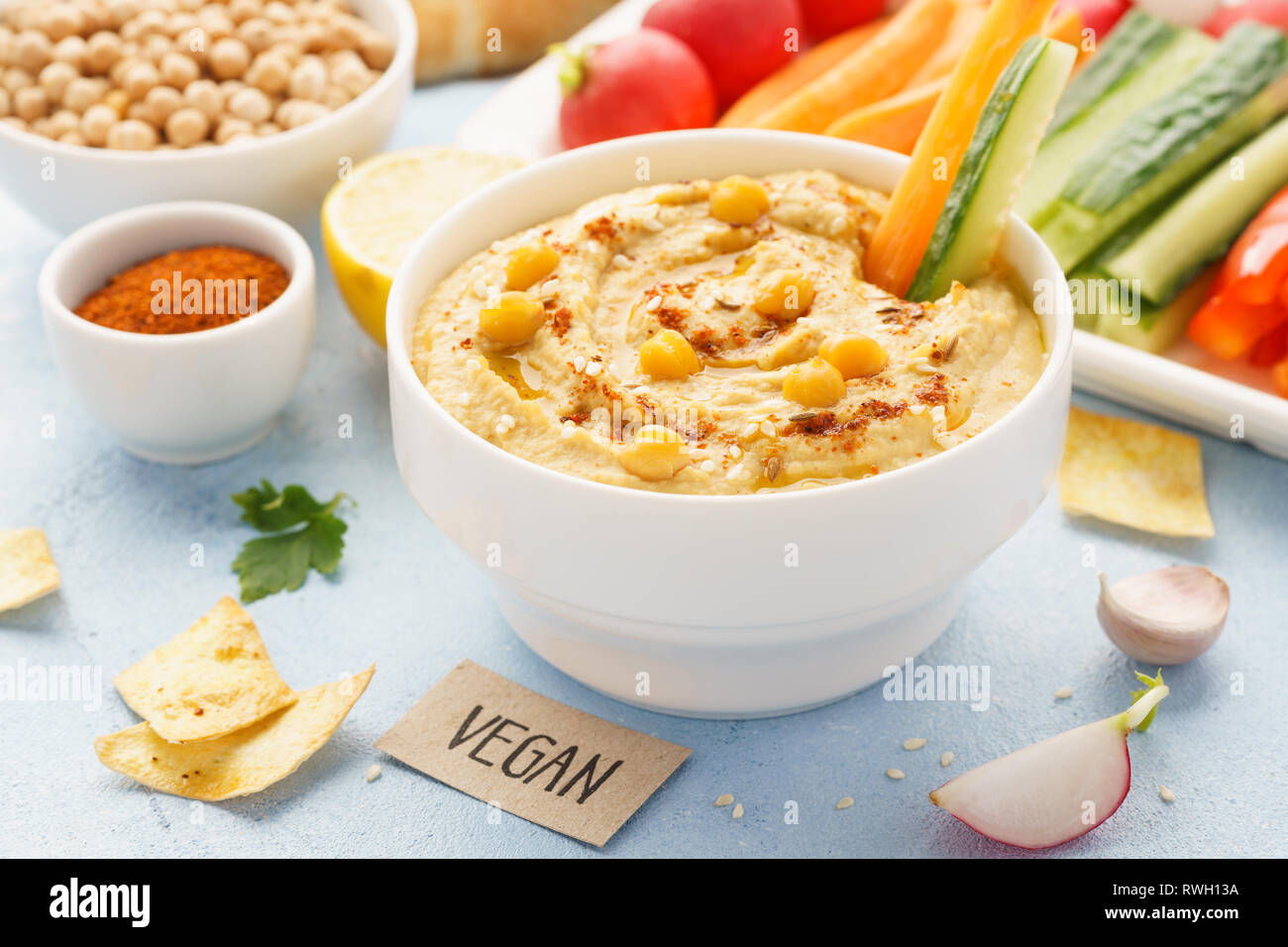 Hummus dip served with fresh vegetable sticks. Healthy vegan food Stock ...