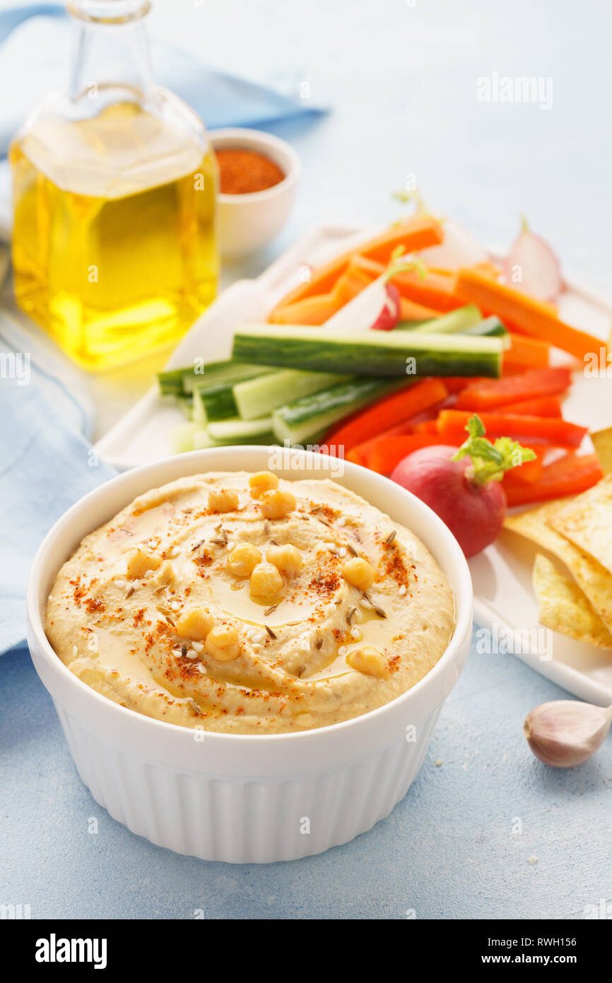 Hummus and variety of vegetable sticks and chips. Healthy vegan snacks ...