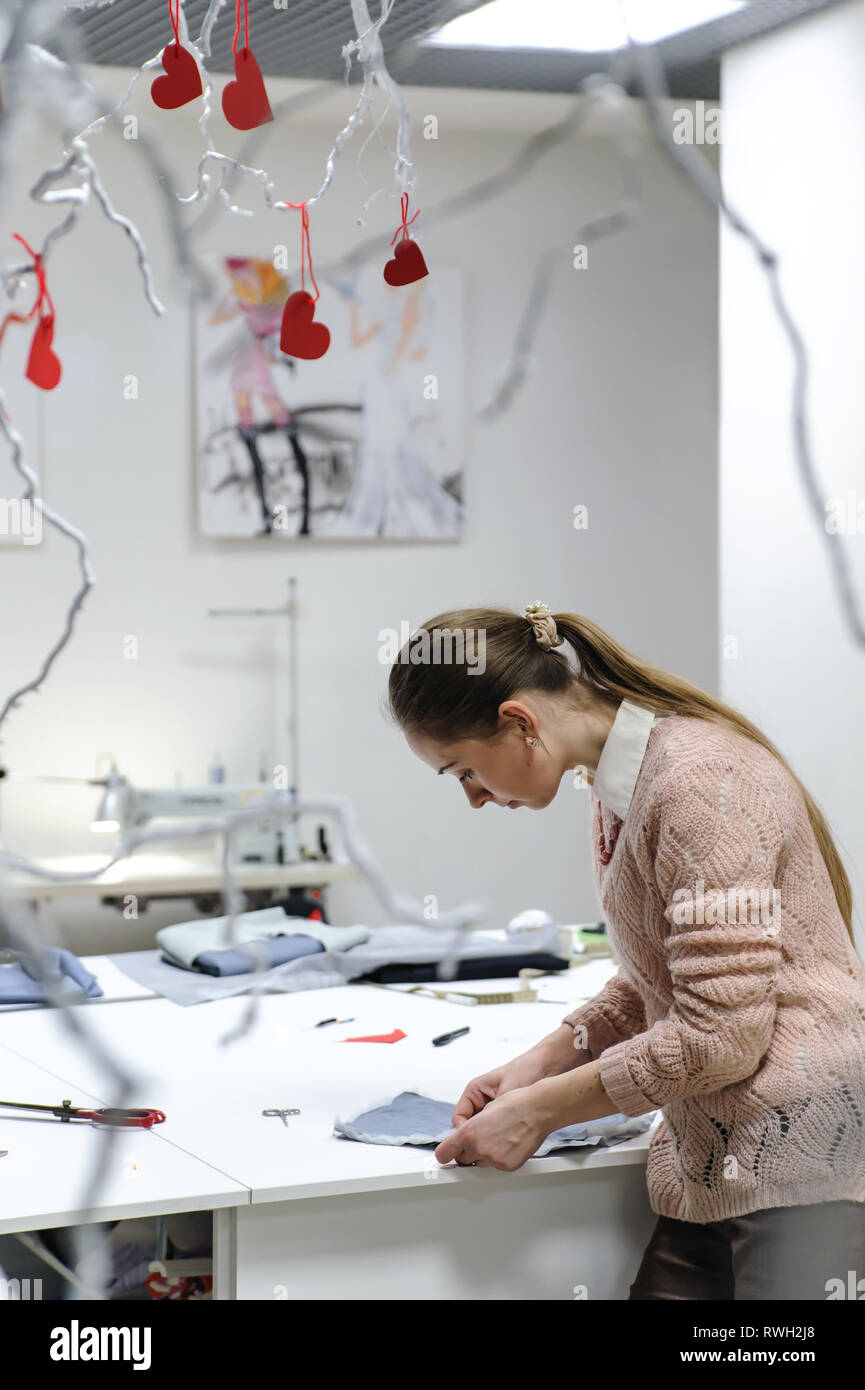 Fashion designer at work. She creates pieces dresses Stock Photo - Alamy