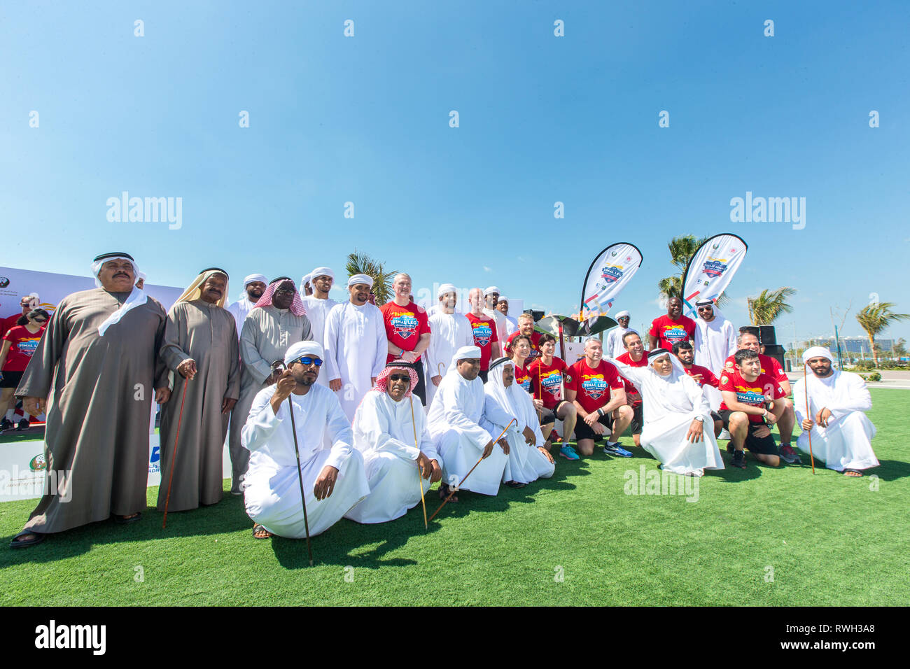 Local Emirati men are seen posing for a picture with the athletes from ...