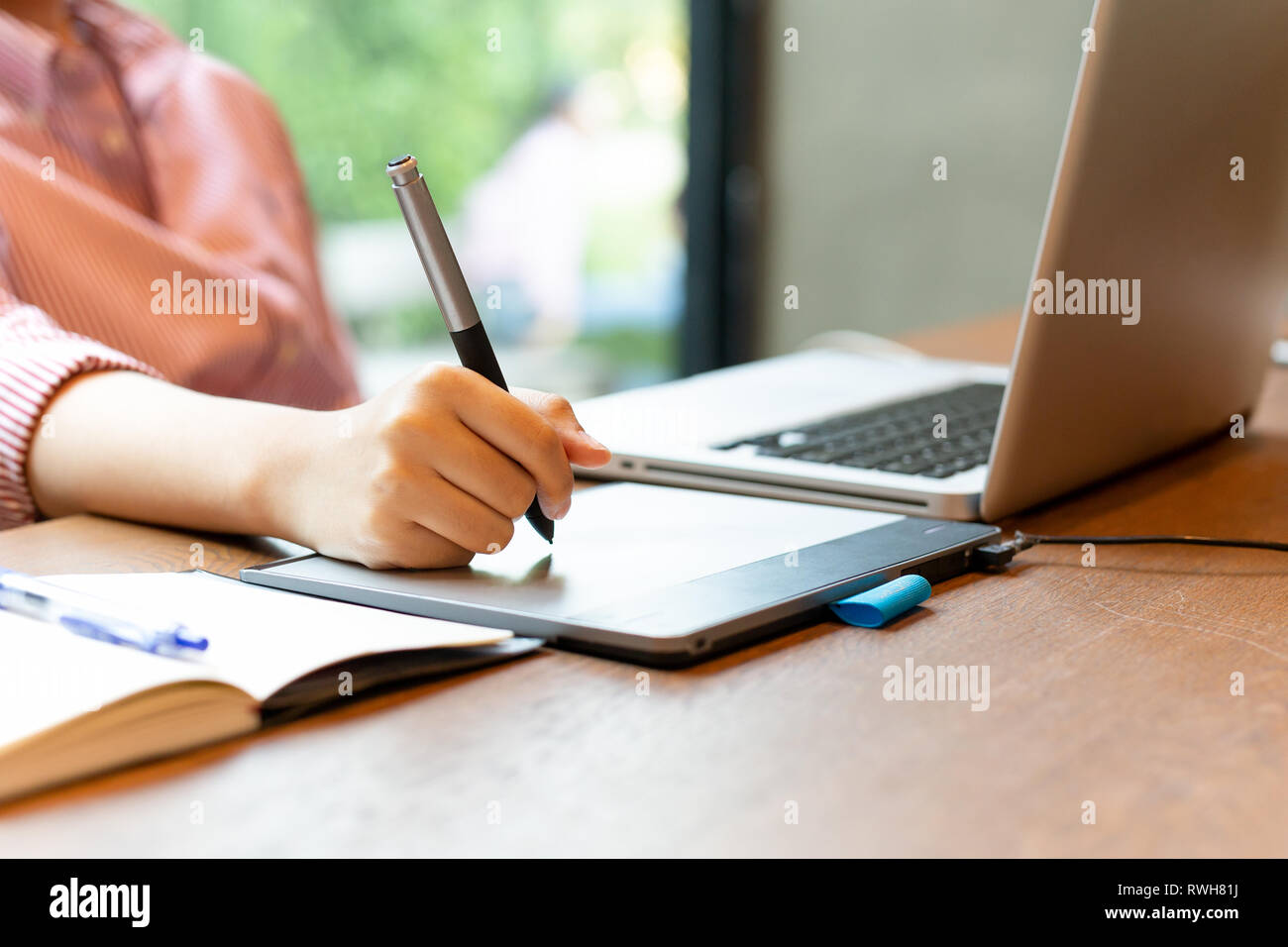 Graphic designer using digital tablet with laptop on the desk Stock ...