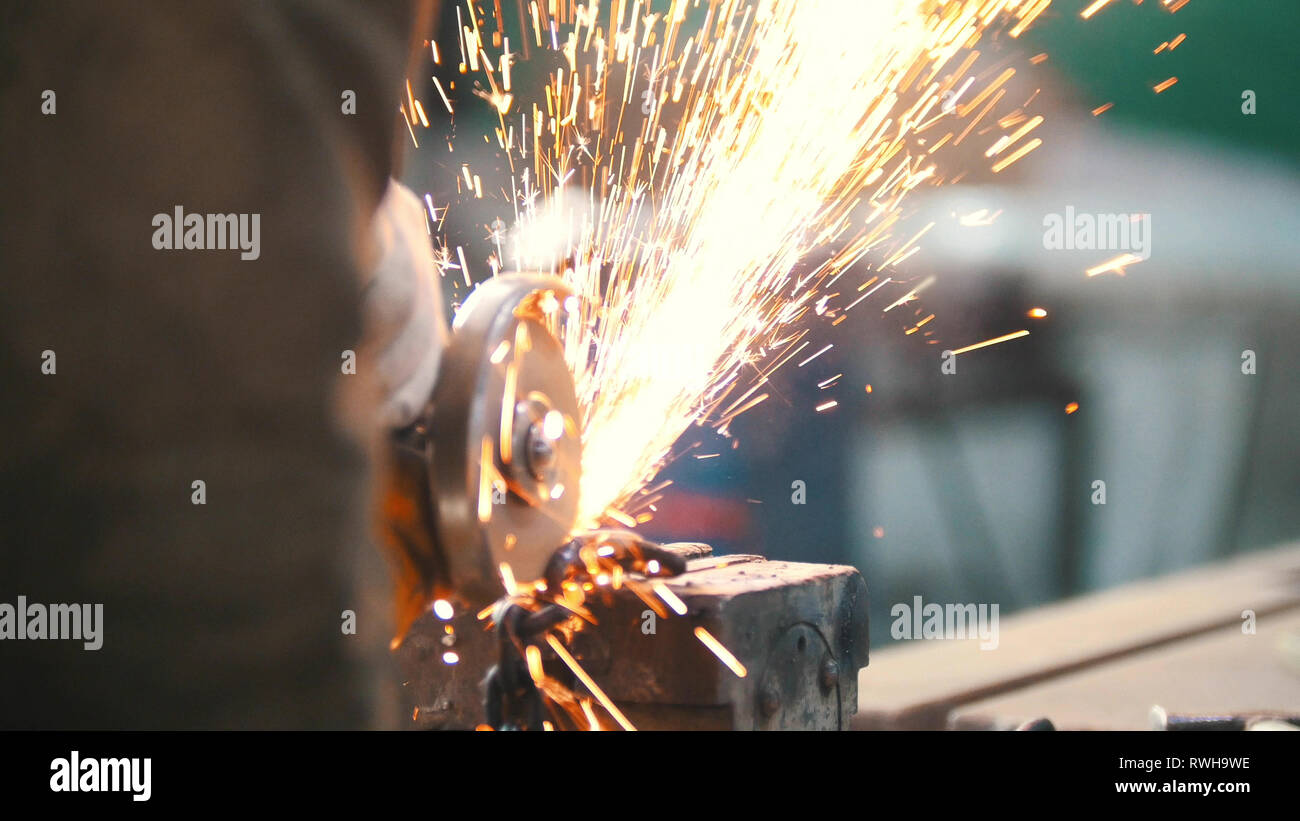 Industrial concept. Construction site. The man worker grinding. Fire ...