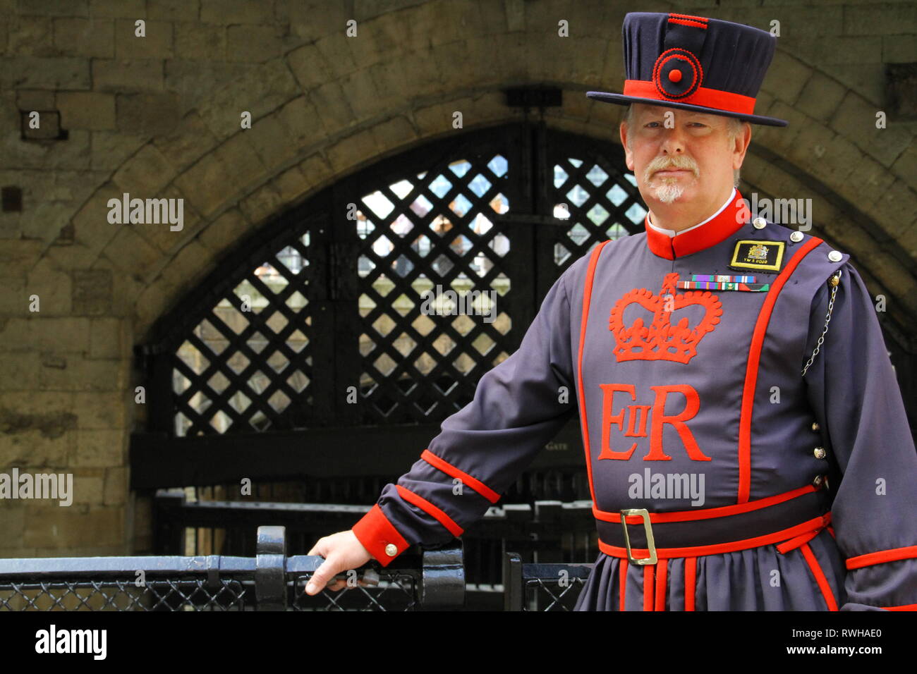 A Yeoman Warder or Beefeater in front of Traitors Gate at the Tower of ...