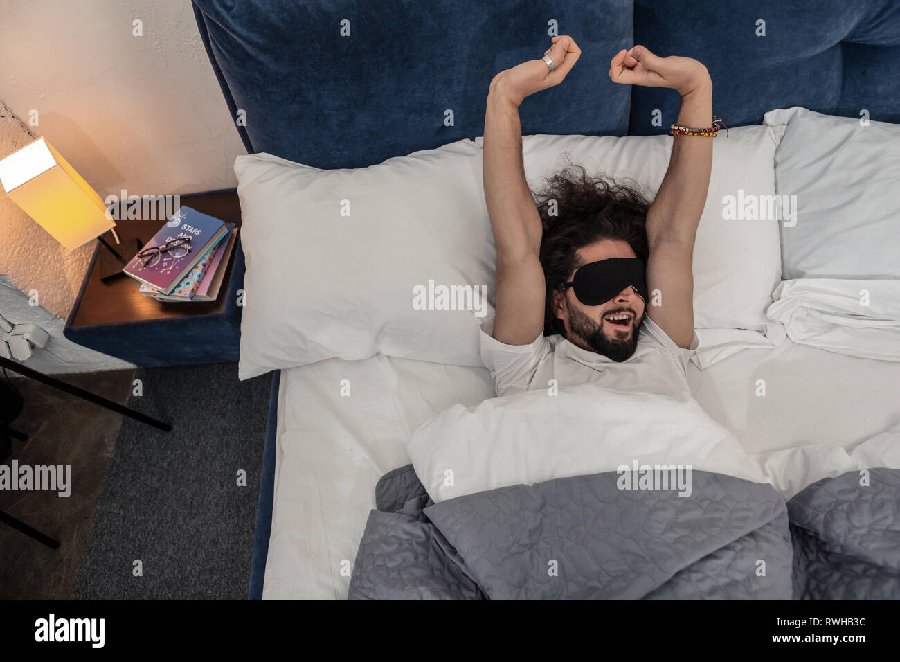 Happy nice man waking up in the morning Stock Photo - Alamy