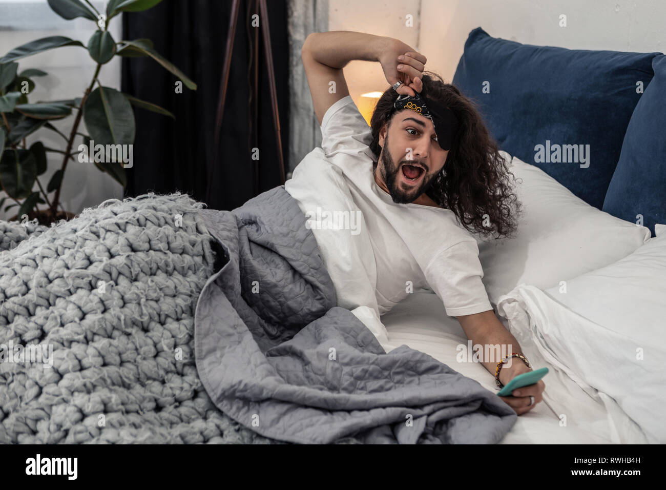 Stressed young man realizing that he is late Stock Photo - Alamy