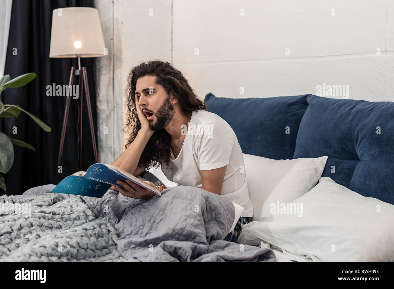 Nice good looking man thinking about sleeping Stock Photo - Alamy