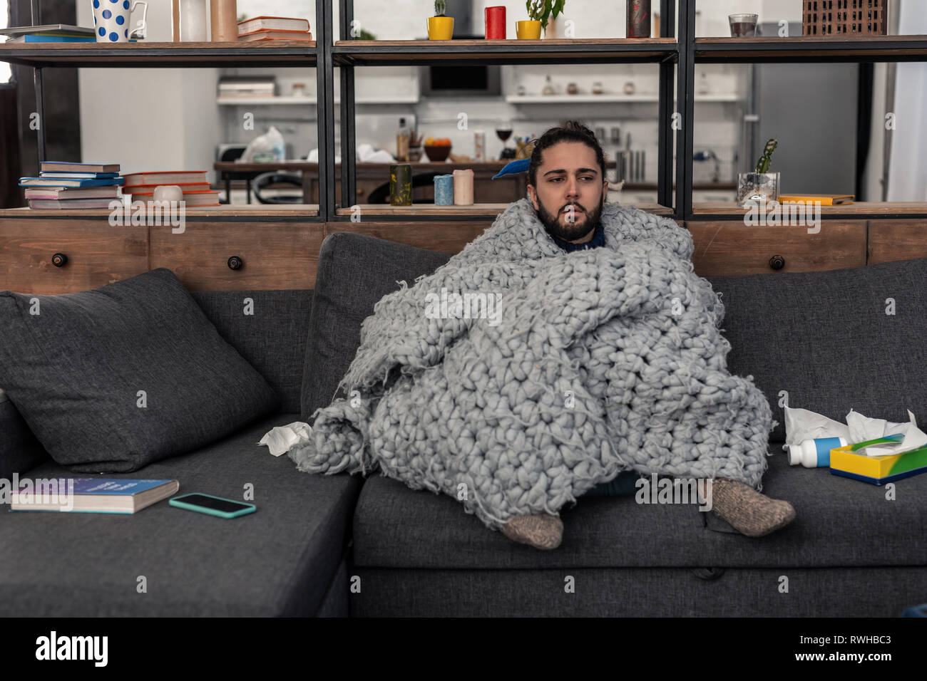 Young sick man wrapped in hi-res stock photography and images - Alamy