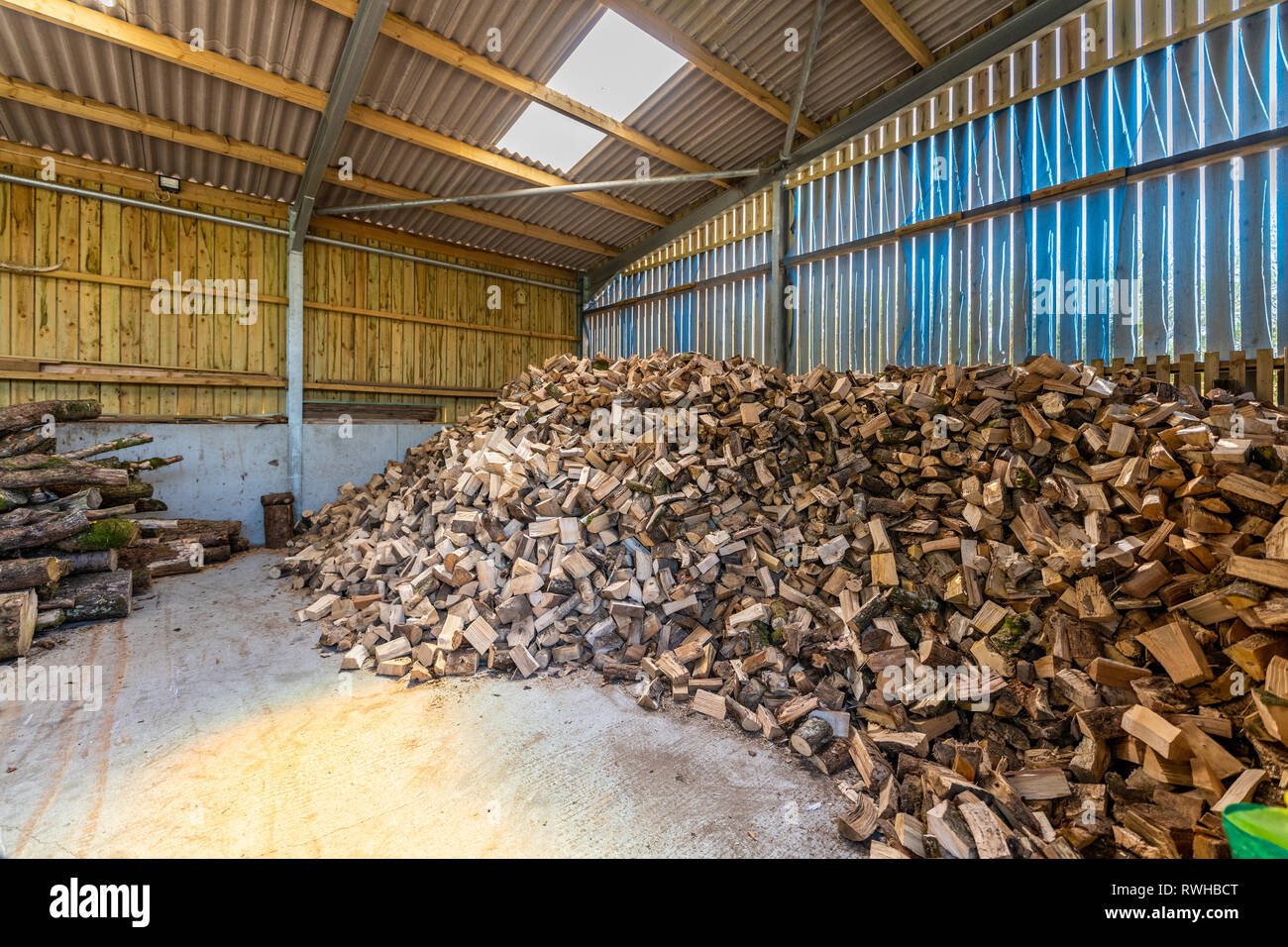 Impressive log stack in renovated barn, Cornwall Stock Photo - Alamy