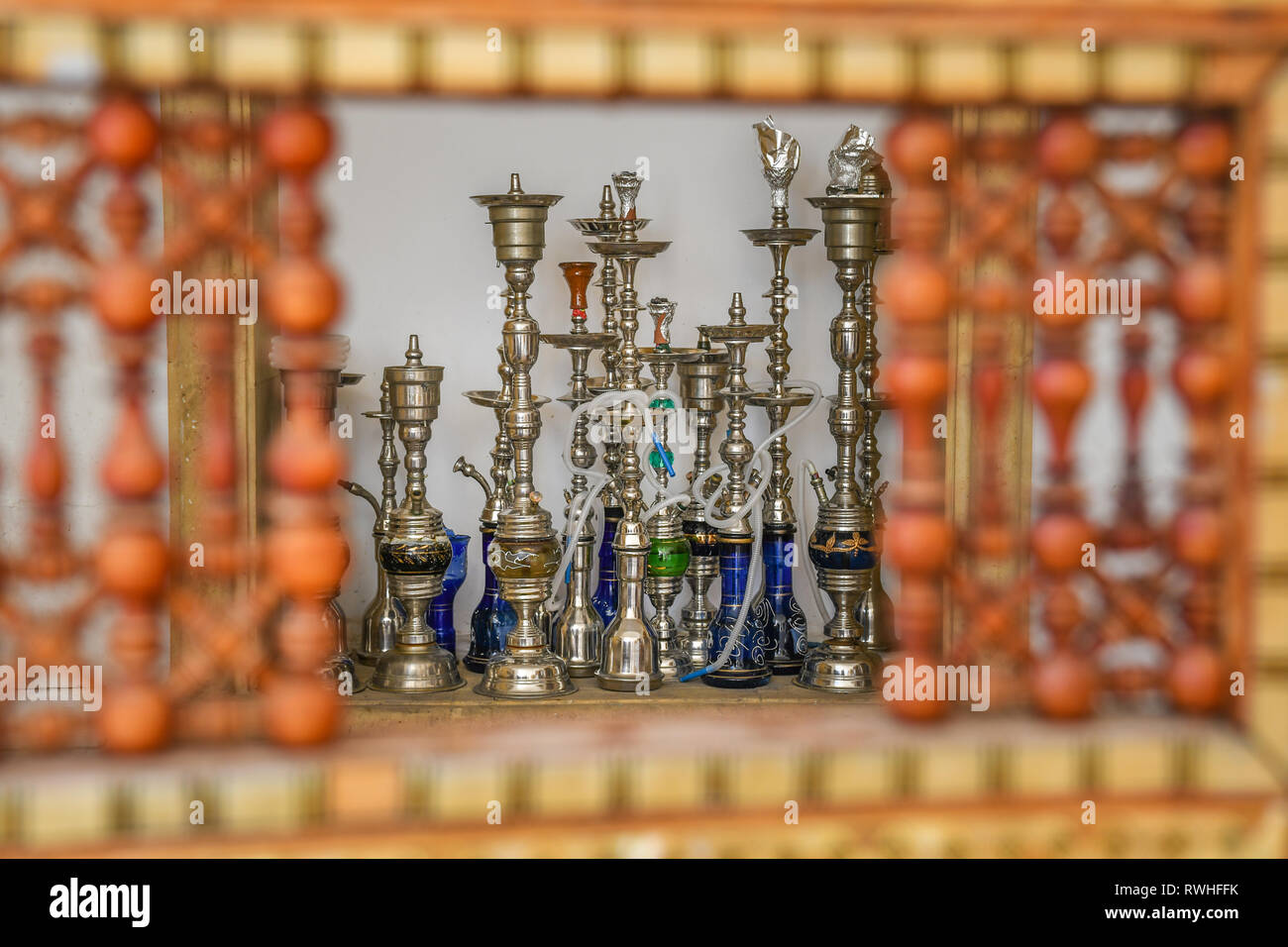 Shisha smoking pipes through oriental red wooden hand crafted wall ...