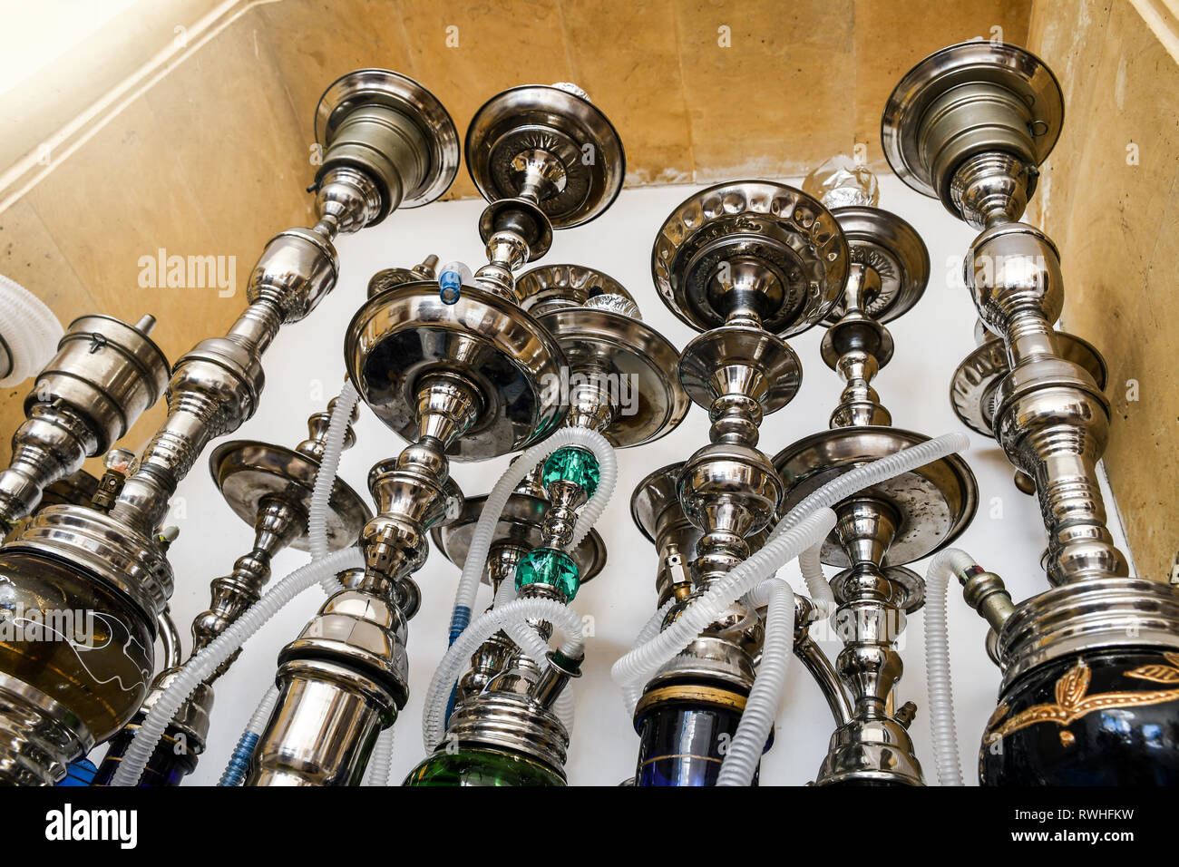 Group of metal shinny shisha water pipes for smoking tobacco on a hot ...