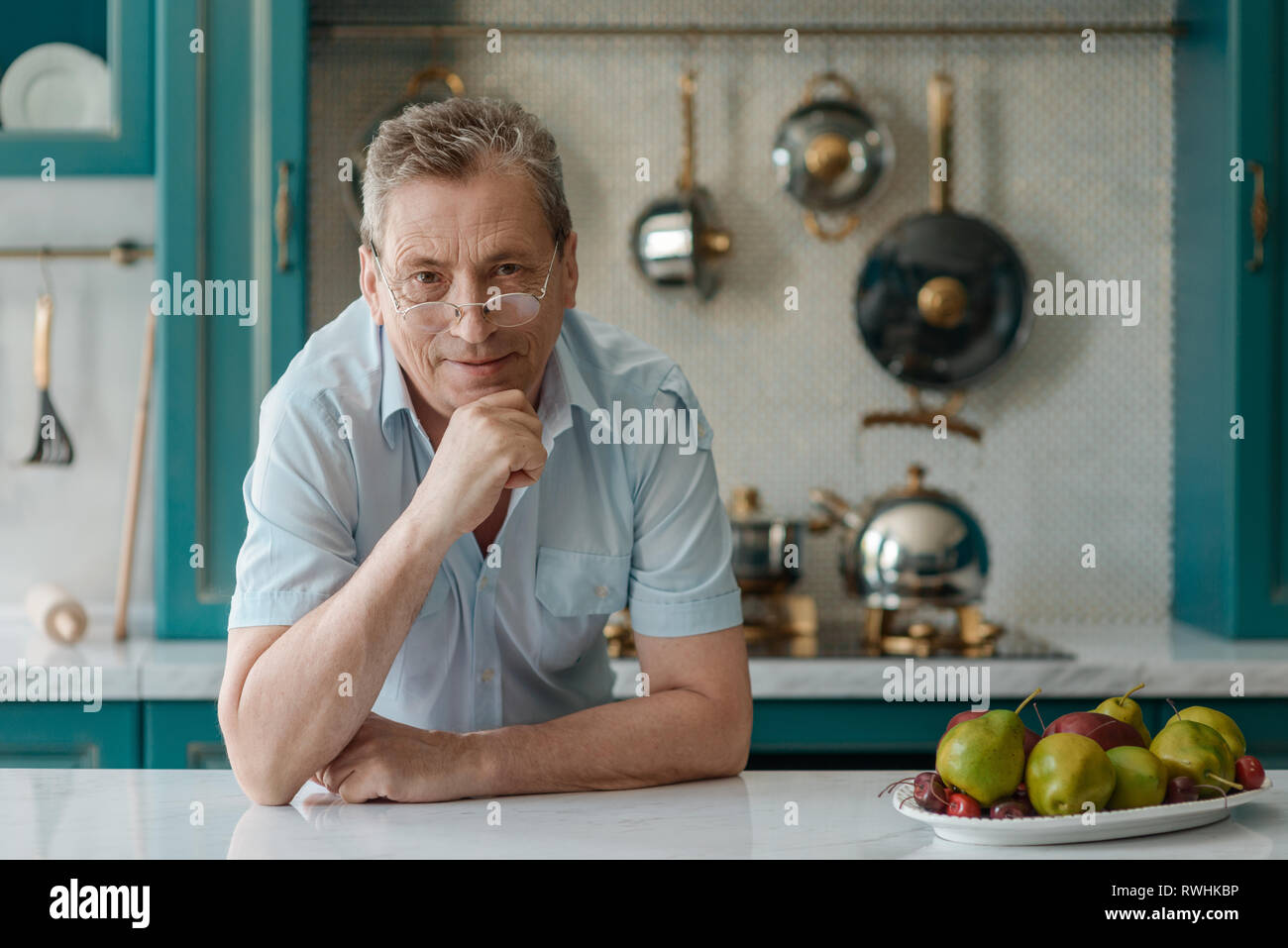 Old man sitting at table Stock Photo - Alamy