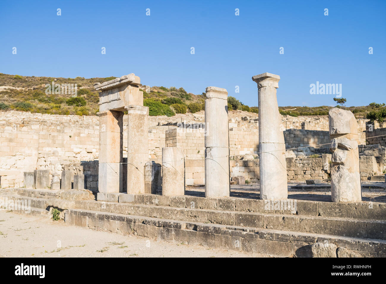 Columns of doric temple in city of Kamiros.Hellenistic houses in ...