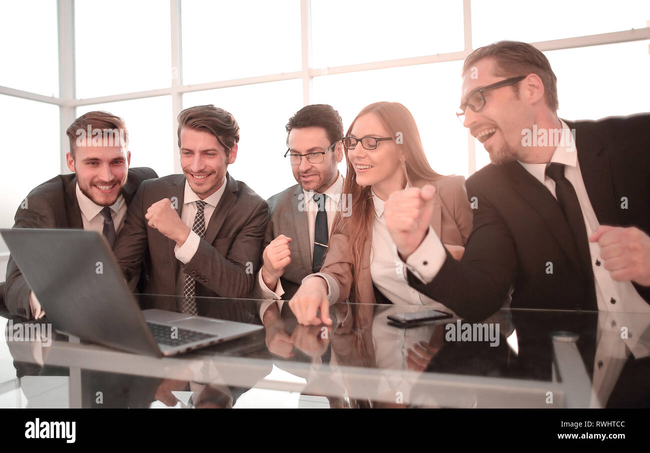 happy colleagues at the desk, hands up Stock Photo - Alamy