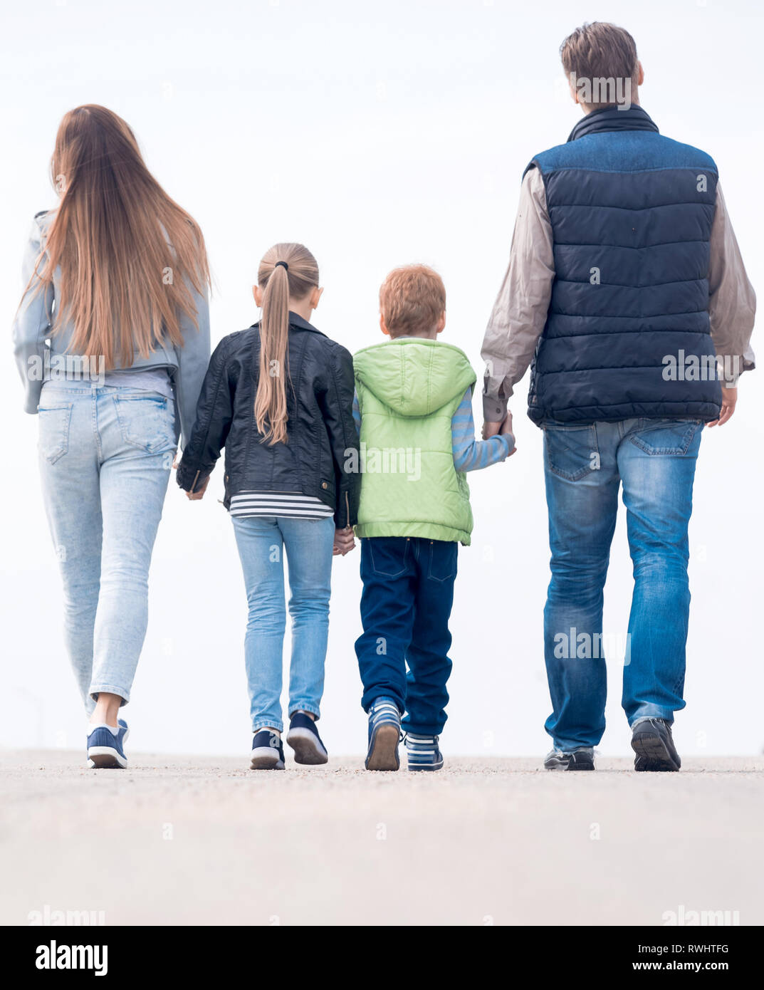 rear view.happy family walking together Stock Photo - Alamy