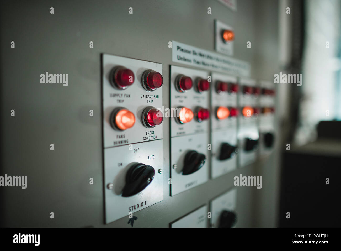 Close up shot of switches and indication lights on an electric board ...