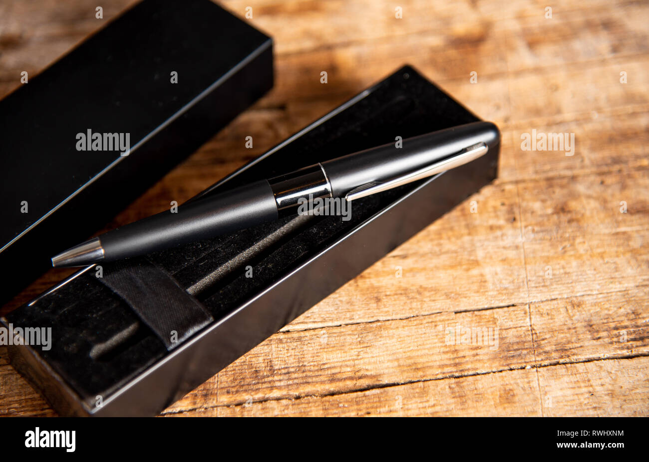 Black pen on a wooden table top view Stock Photo - Alamy