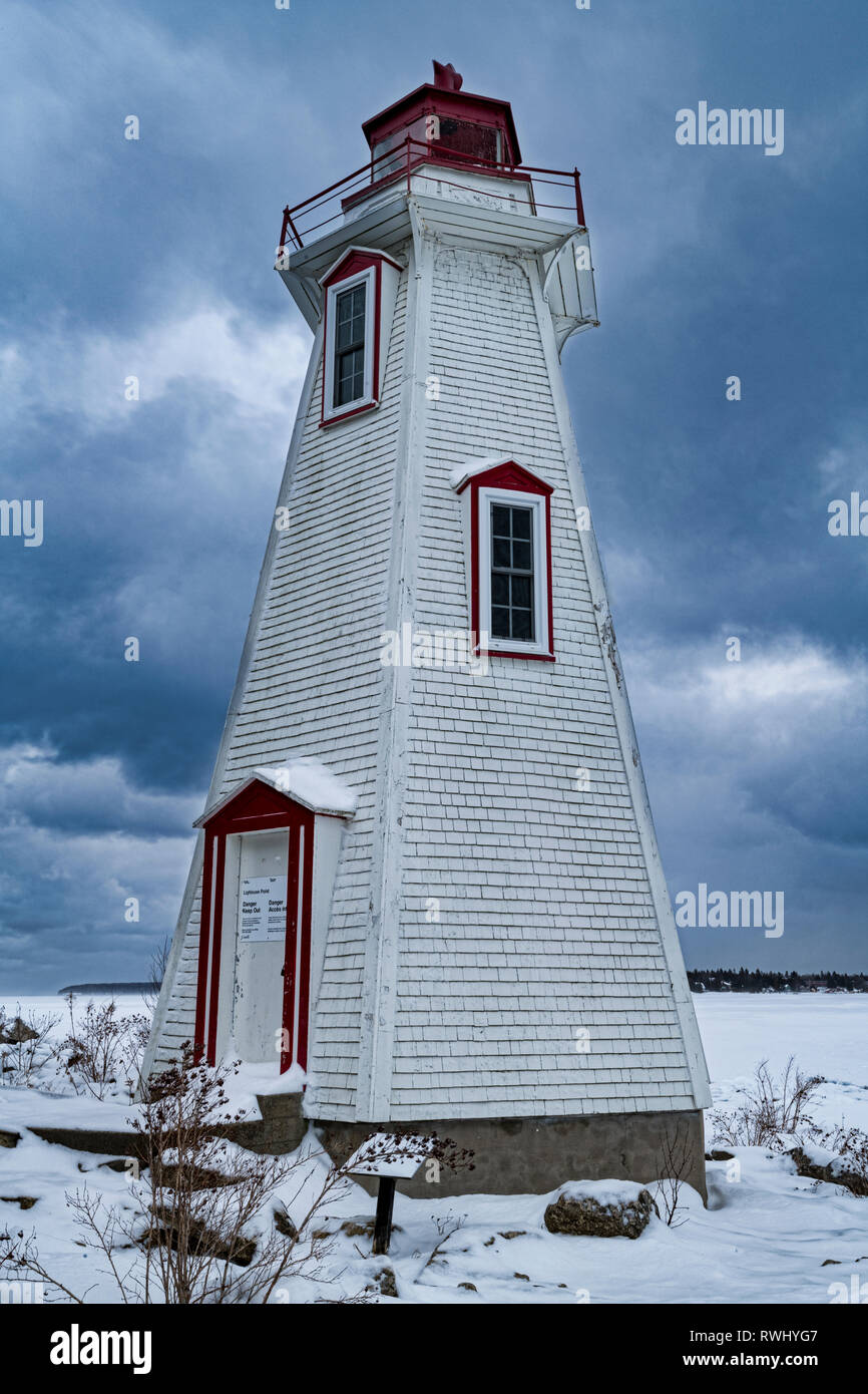 Lighthouse stands as a lonely sentinel against a cold hi-res stock ...