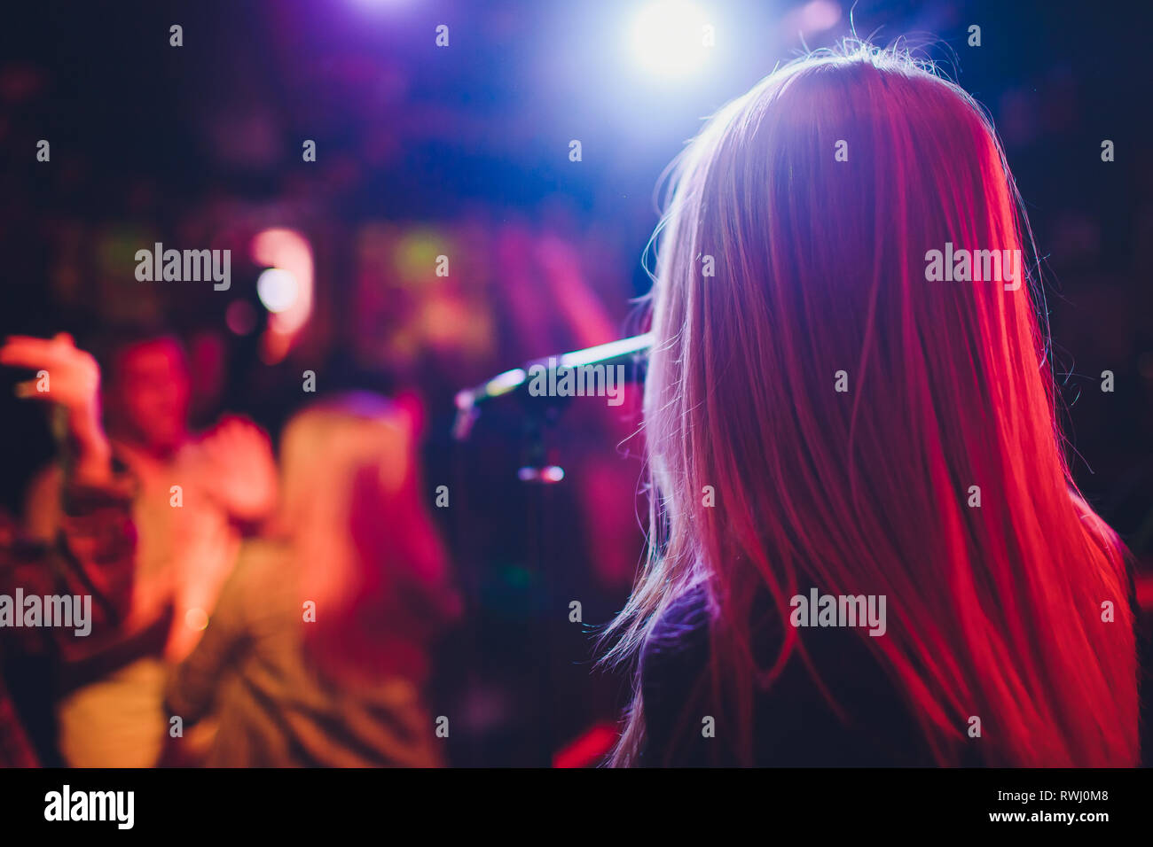 Entertianment at a wedding. A female singer is interacting with the ...