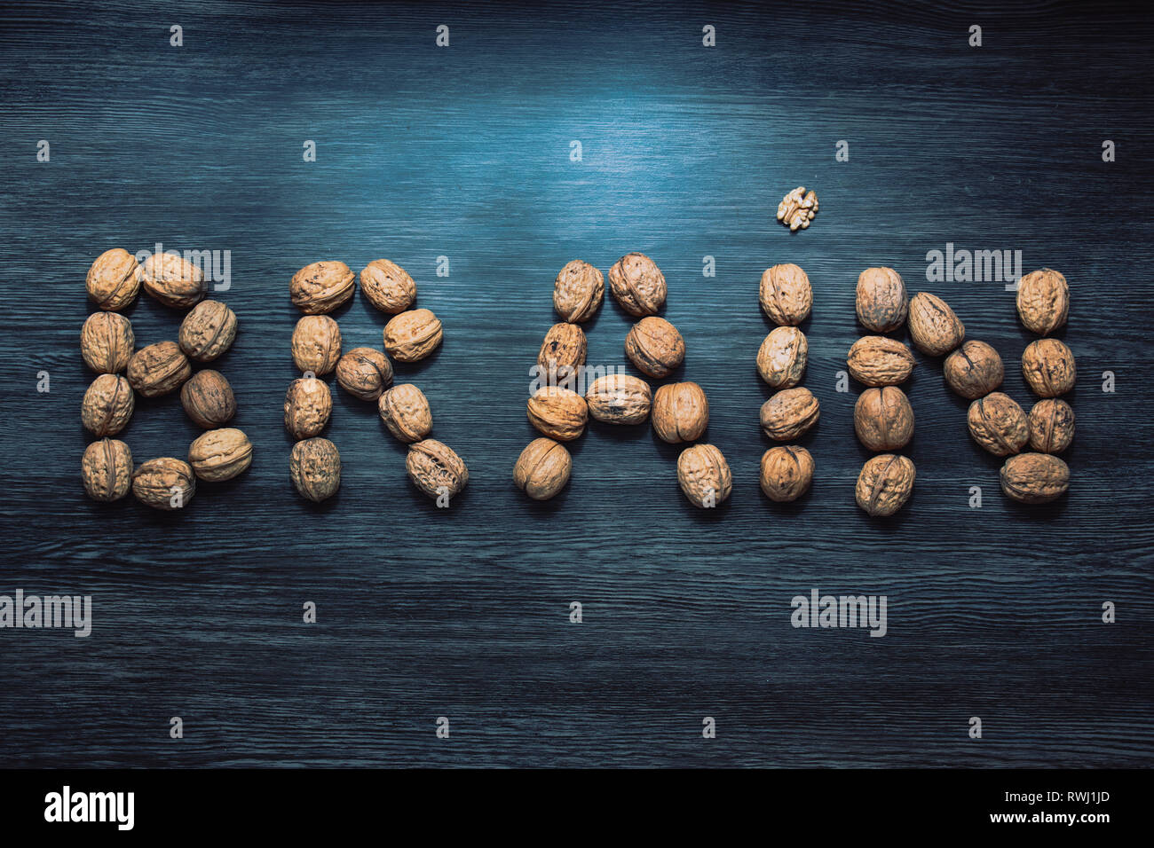 Brain letters sign made with walnuts against blue background. Brain ...
