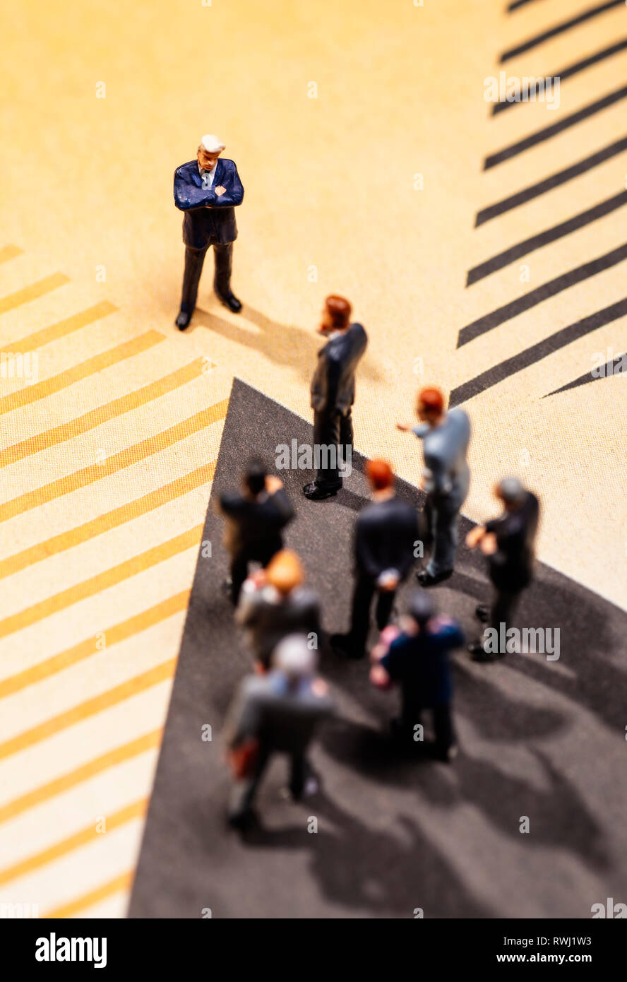 A group of figures with one figure as leader Stock Photo - Alamy