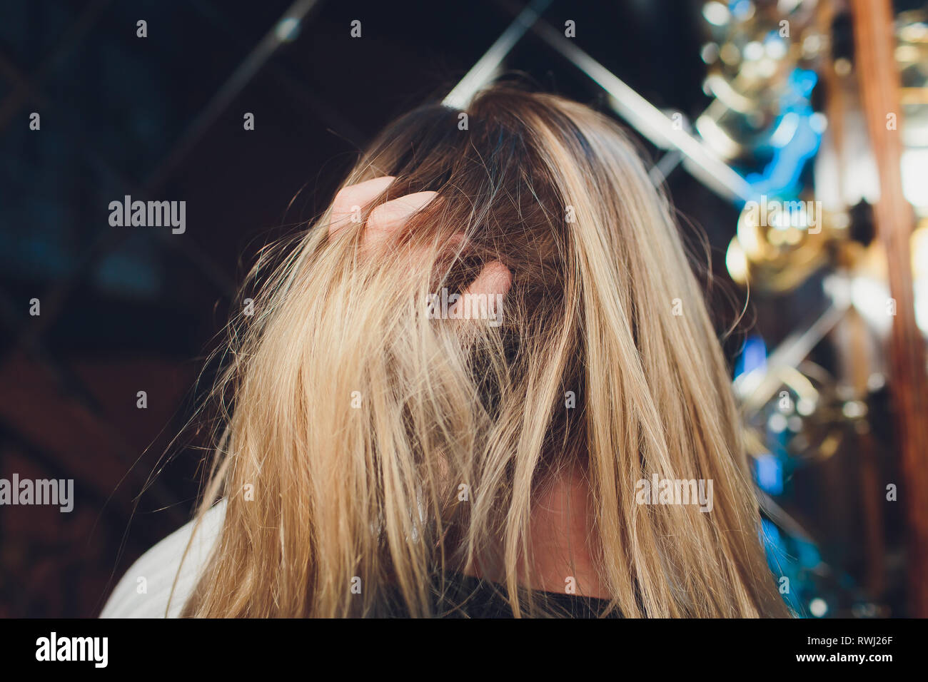 Fury and big anger inside of people. Blonde furious woman pulling blonde hair out of head ...