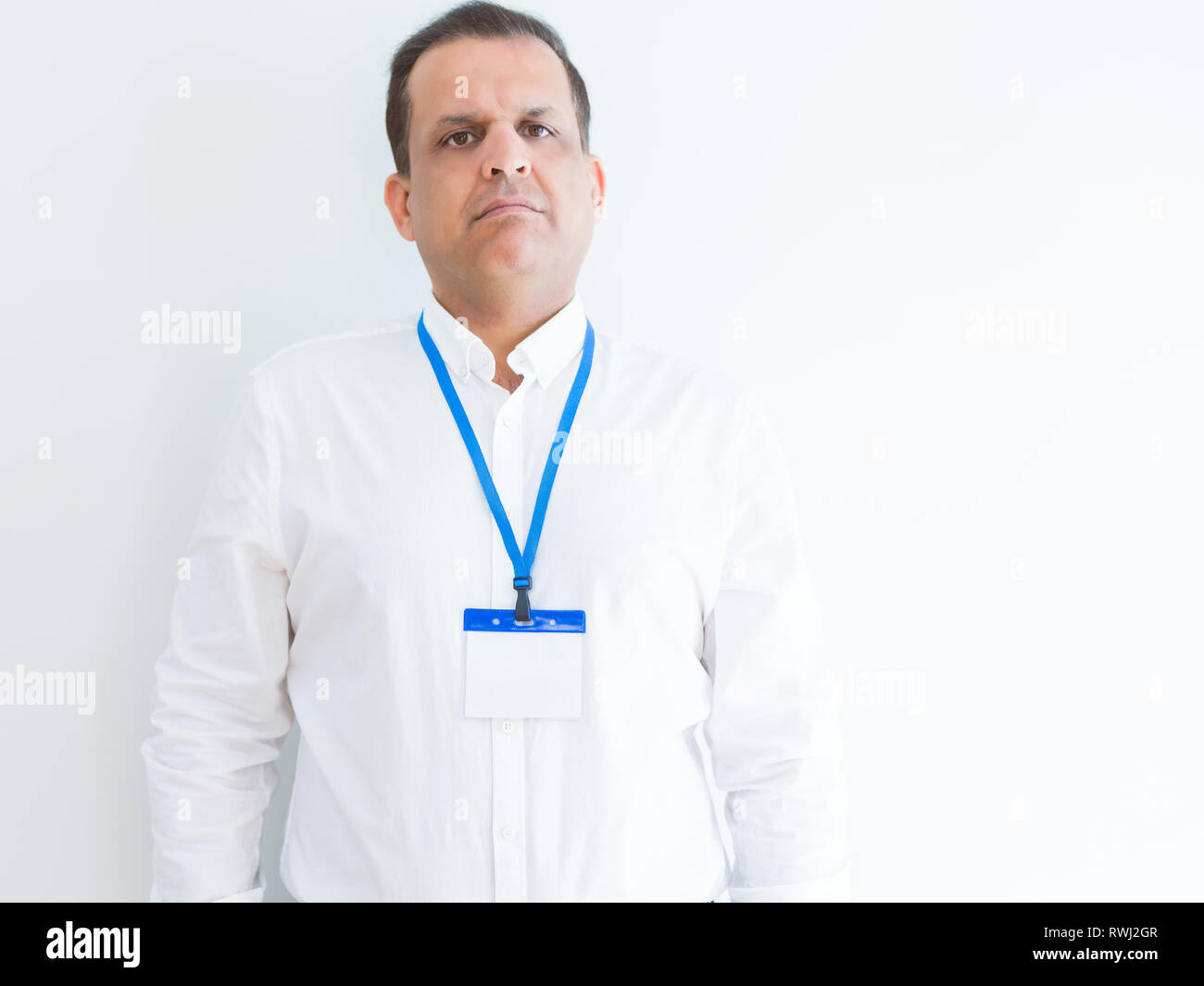 Middle age business man wearing ID card over white background with ...