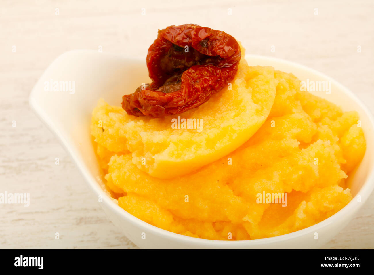 Polenta with dry tomato Stock Photo - Alamy