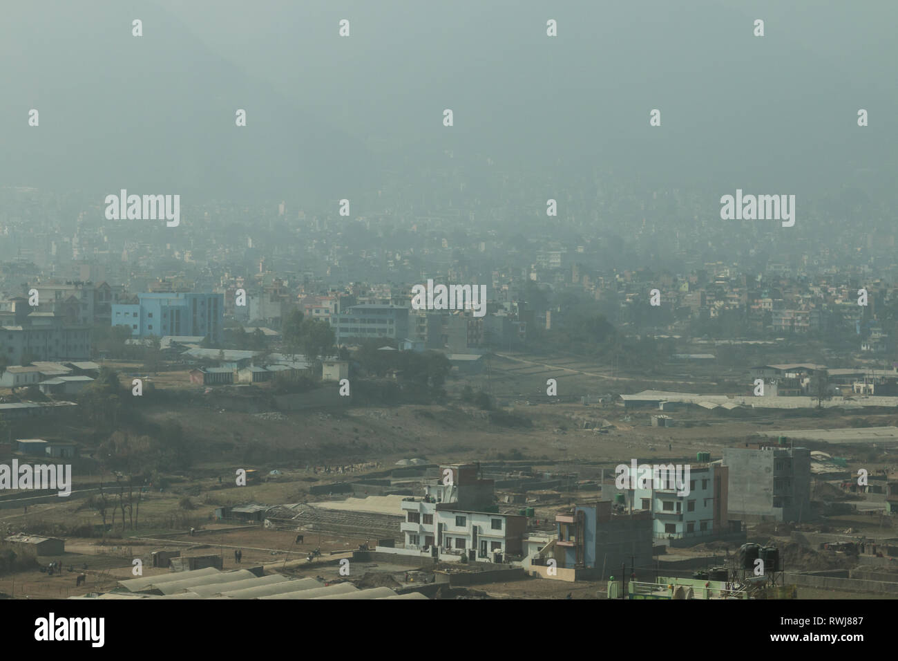 Heavy pollution and smog hang in the air over Kathmandu valley, Nepal, causing health concerns ...