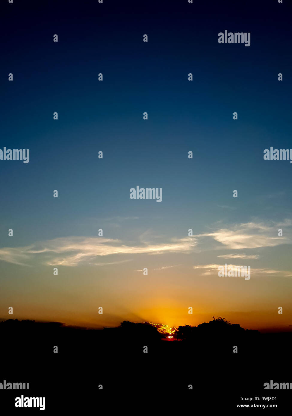 A portrait of a beautiful sunset with a sky with graduated colors from ...