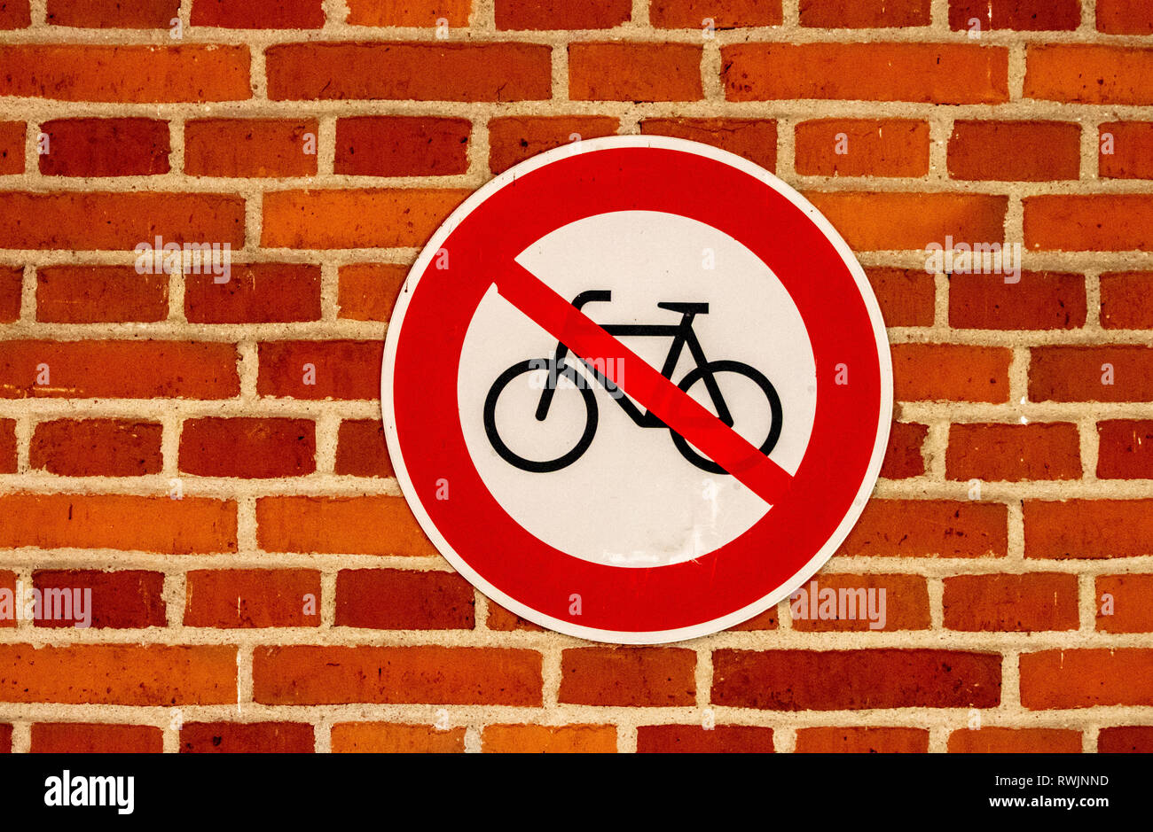 no bike allowed warning road sign on red brick wall background with ...
