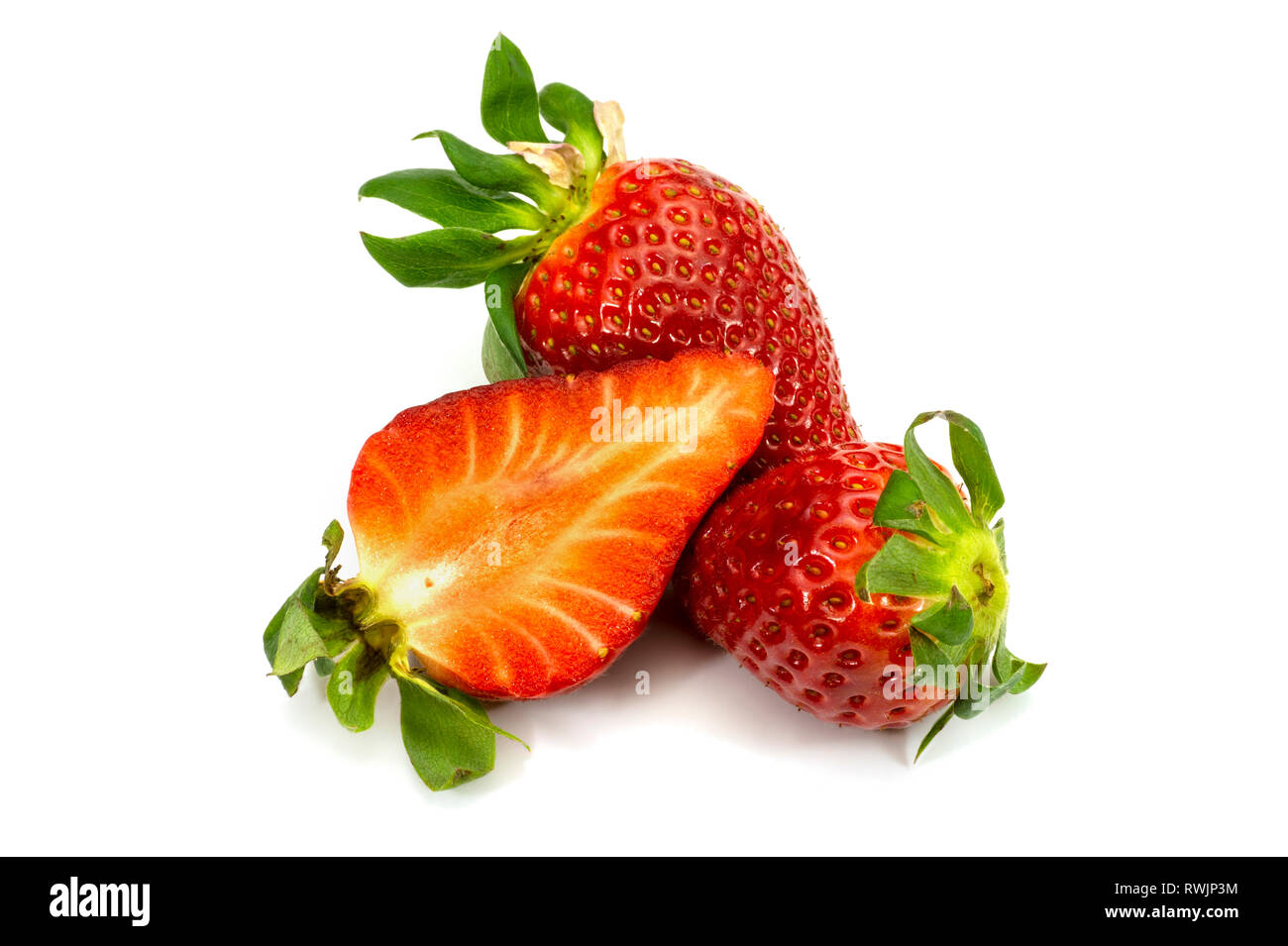 Two whole strawberry fruits and half isolated on white background Stock ...