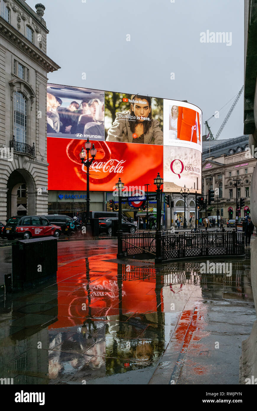 Piccadilly Circus, London in the rain showing the reflections on the ...