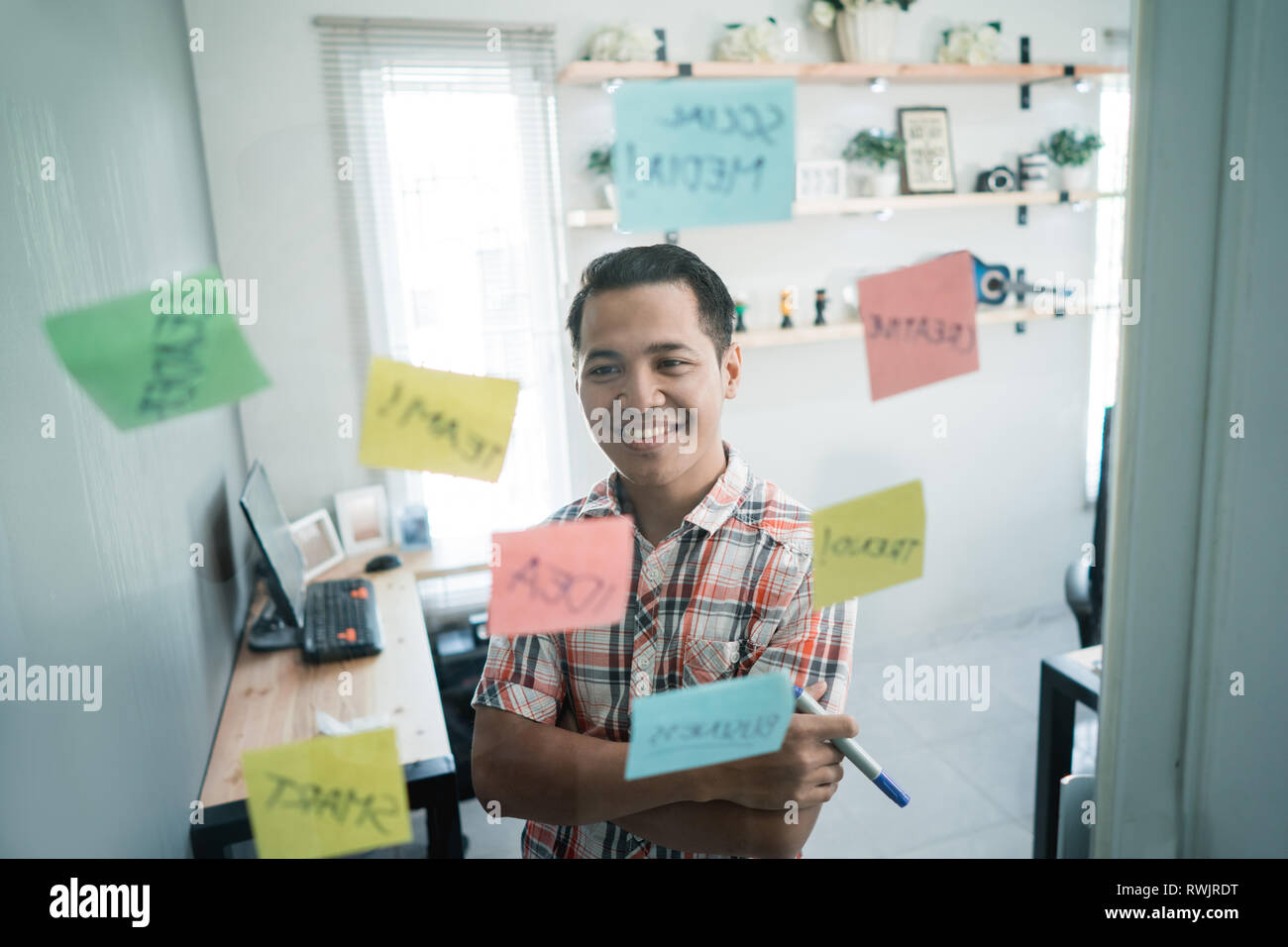 asian young man look at the paper and think of some good ideas Stock ...