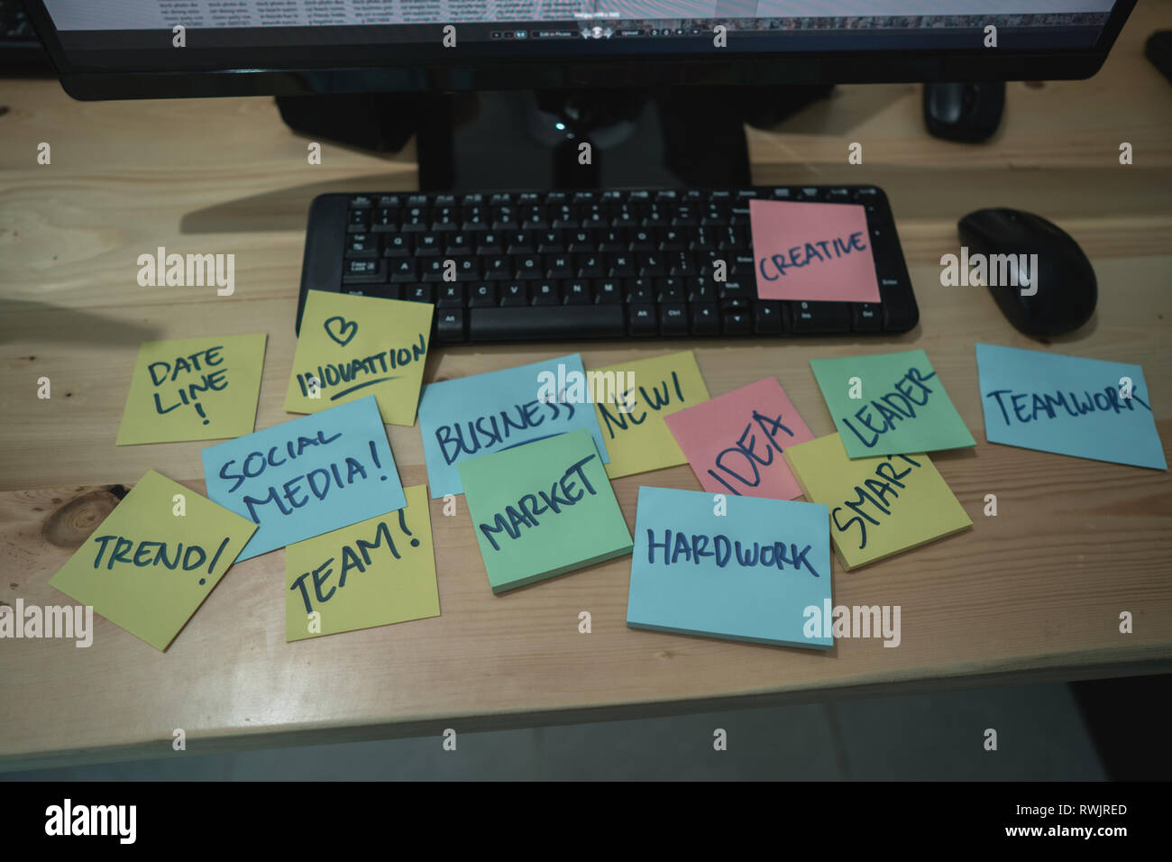 portrait of many paper note on the table in front of monitor computer ...