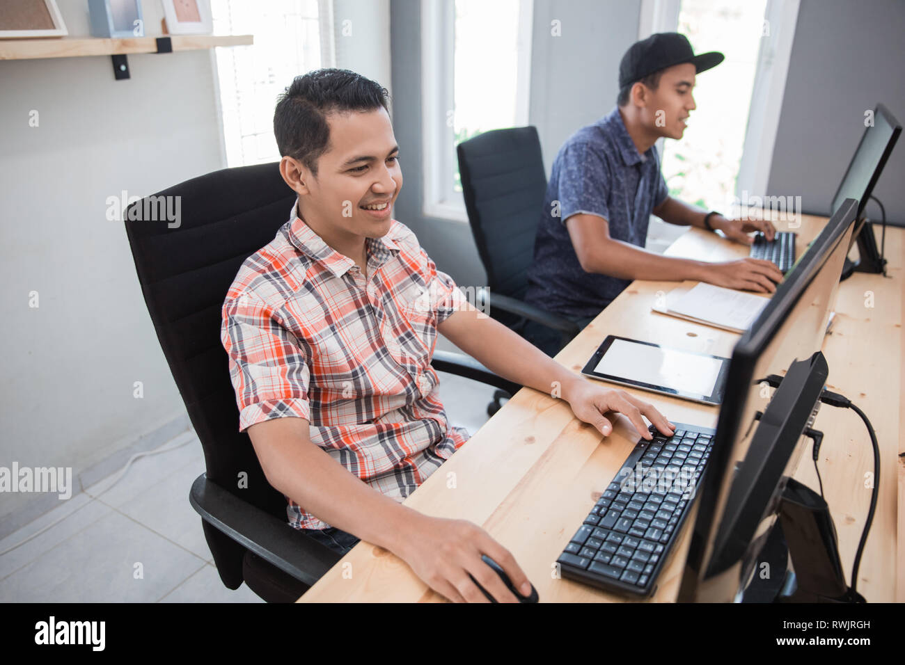 people working looking at their pc Stock Photo - Alamy