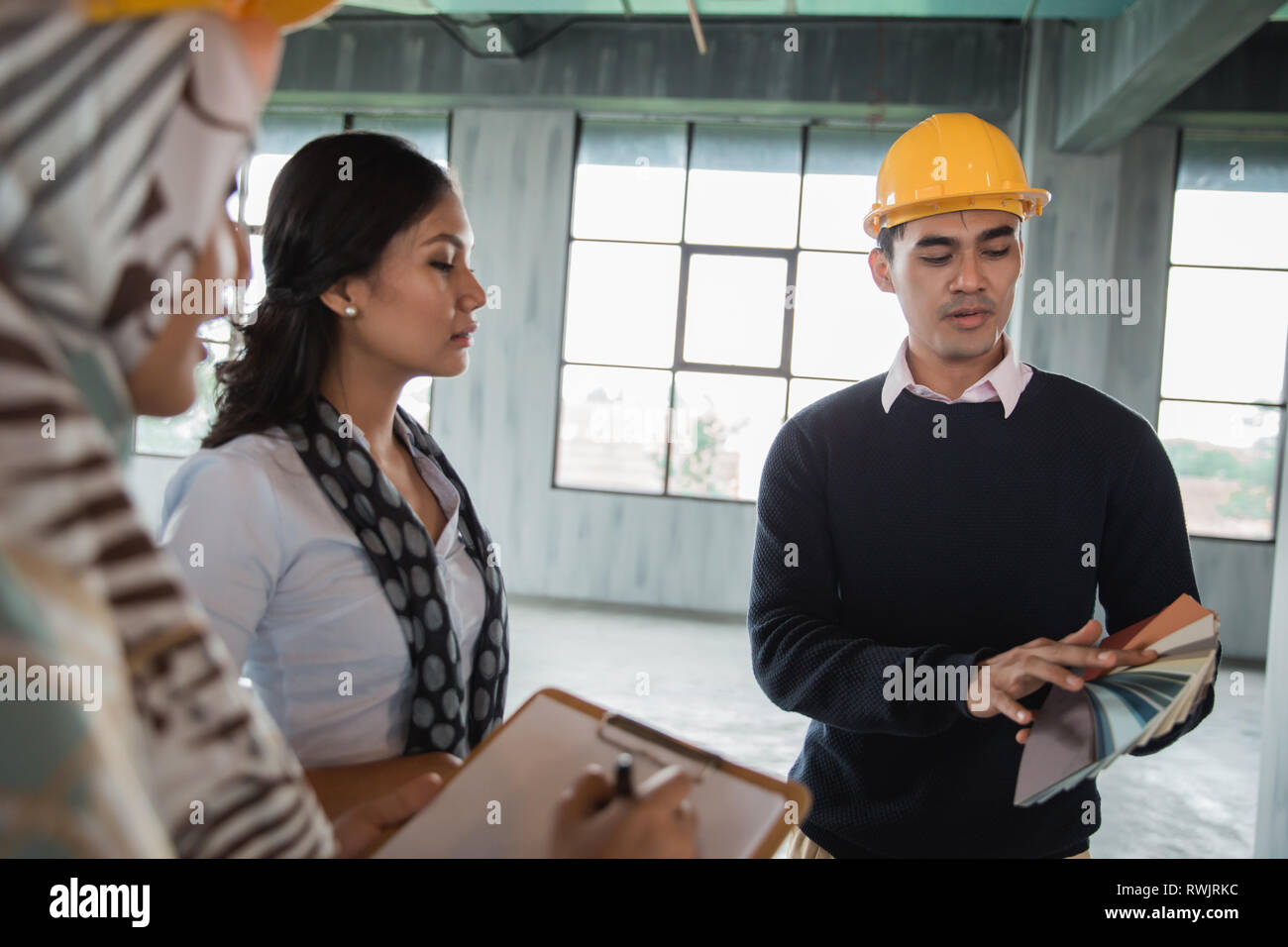 group of engineer talking about paint color the outdoor wall project ...