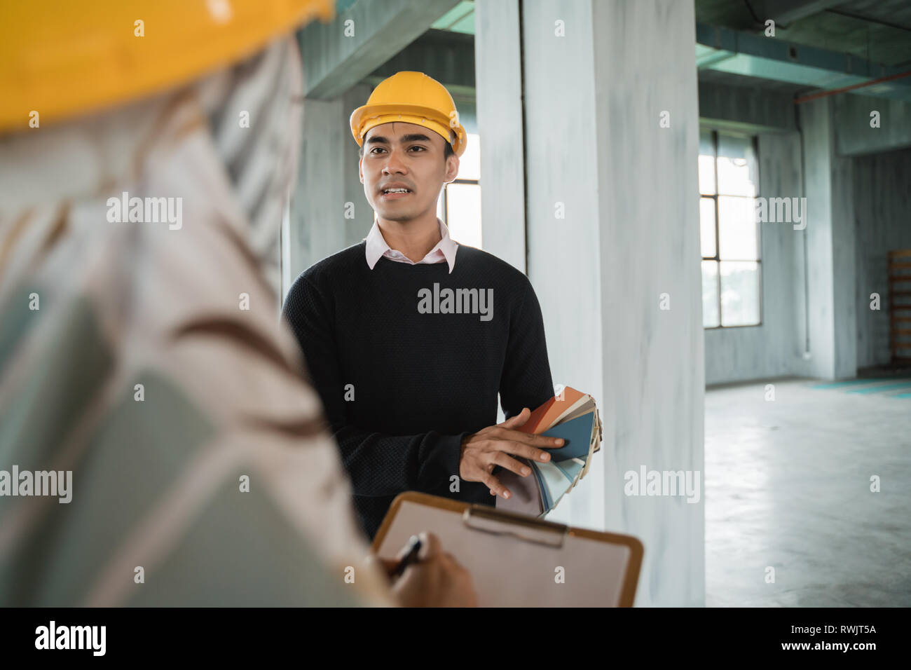 head engineer with safety helmet make instruction for women engineer ...