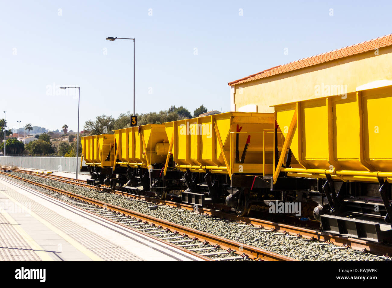 Ballast train. A large cargo yellow train at the station Stock Photo ...