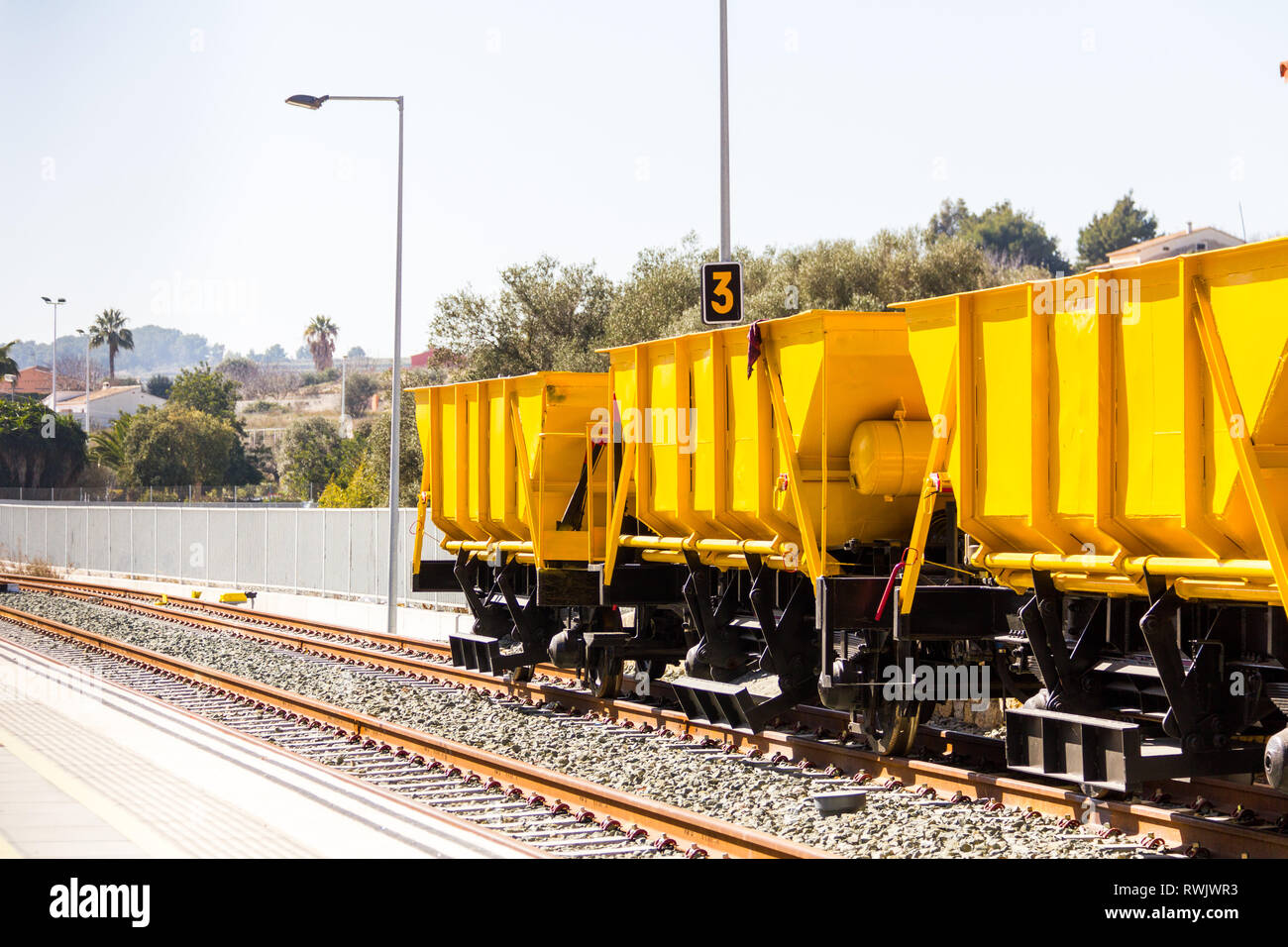Ballast train. A large cargo yellow train at the station Stock Photo ...