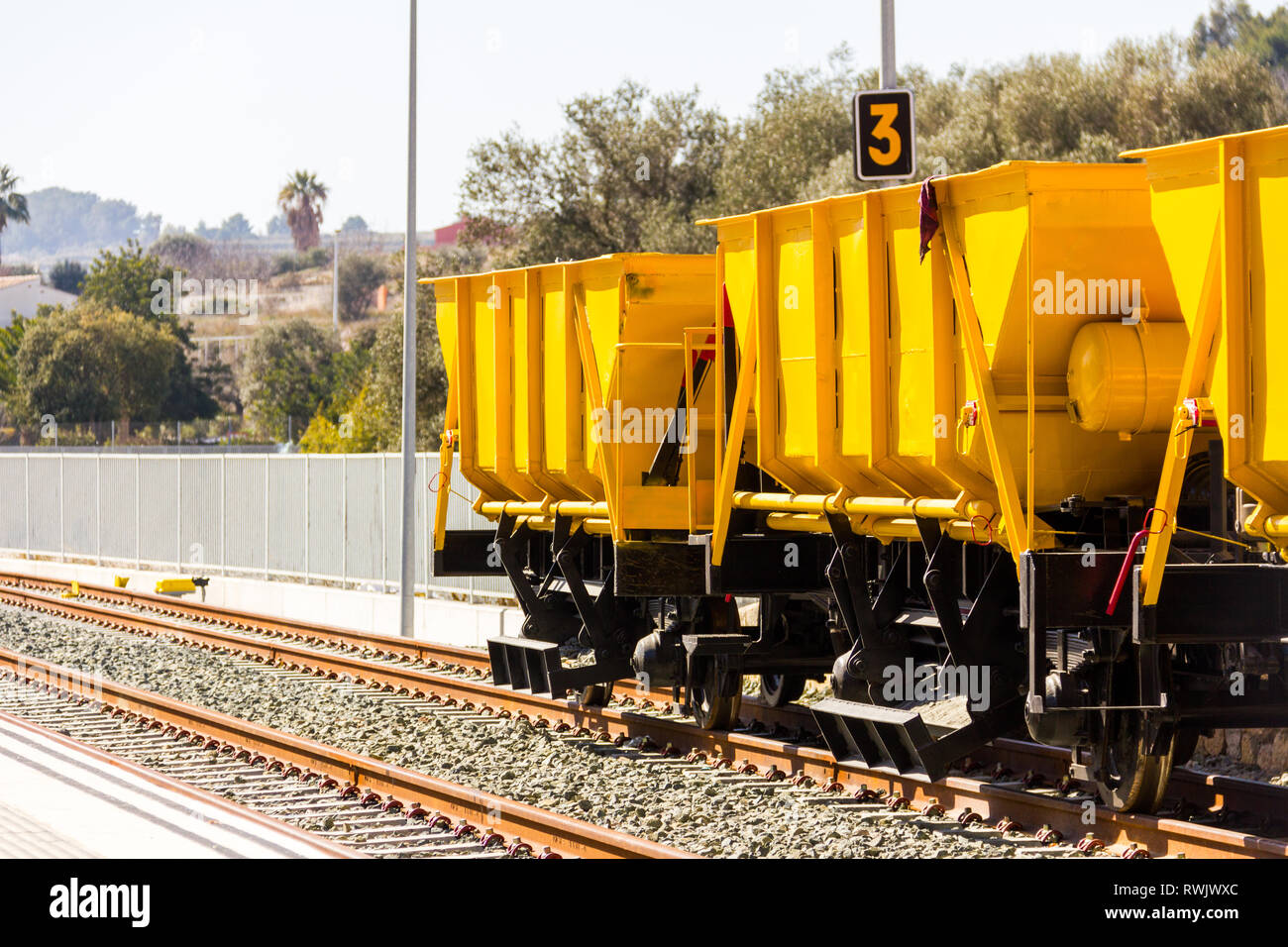 Ballast train. A large cargo yellow train at the station Stock Photo ...