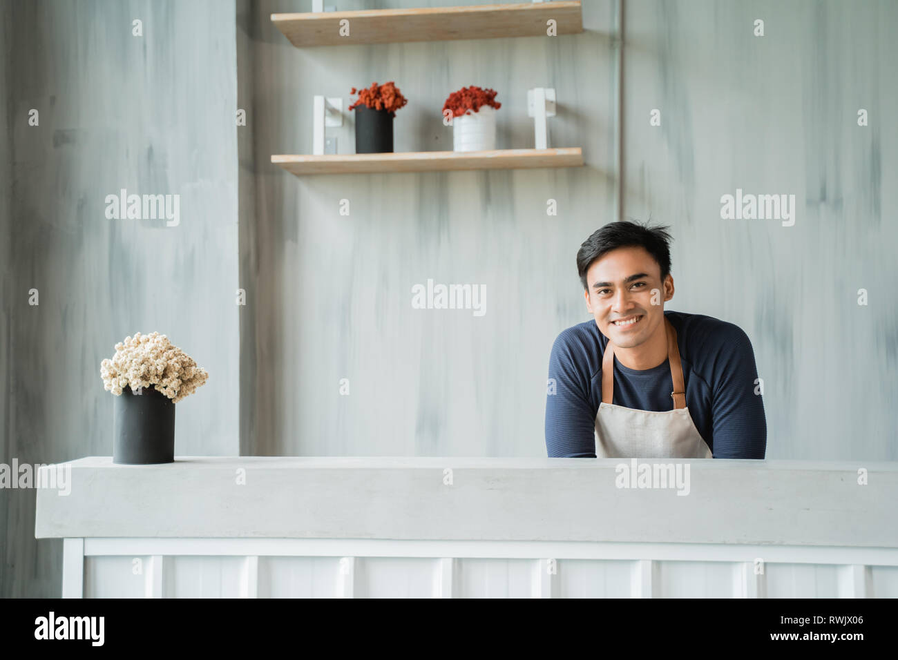 young man barista standing back and smile behind table bar Stock Photo ...